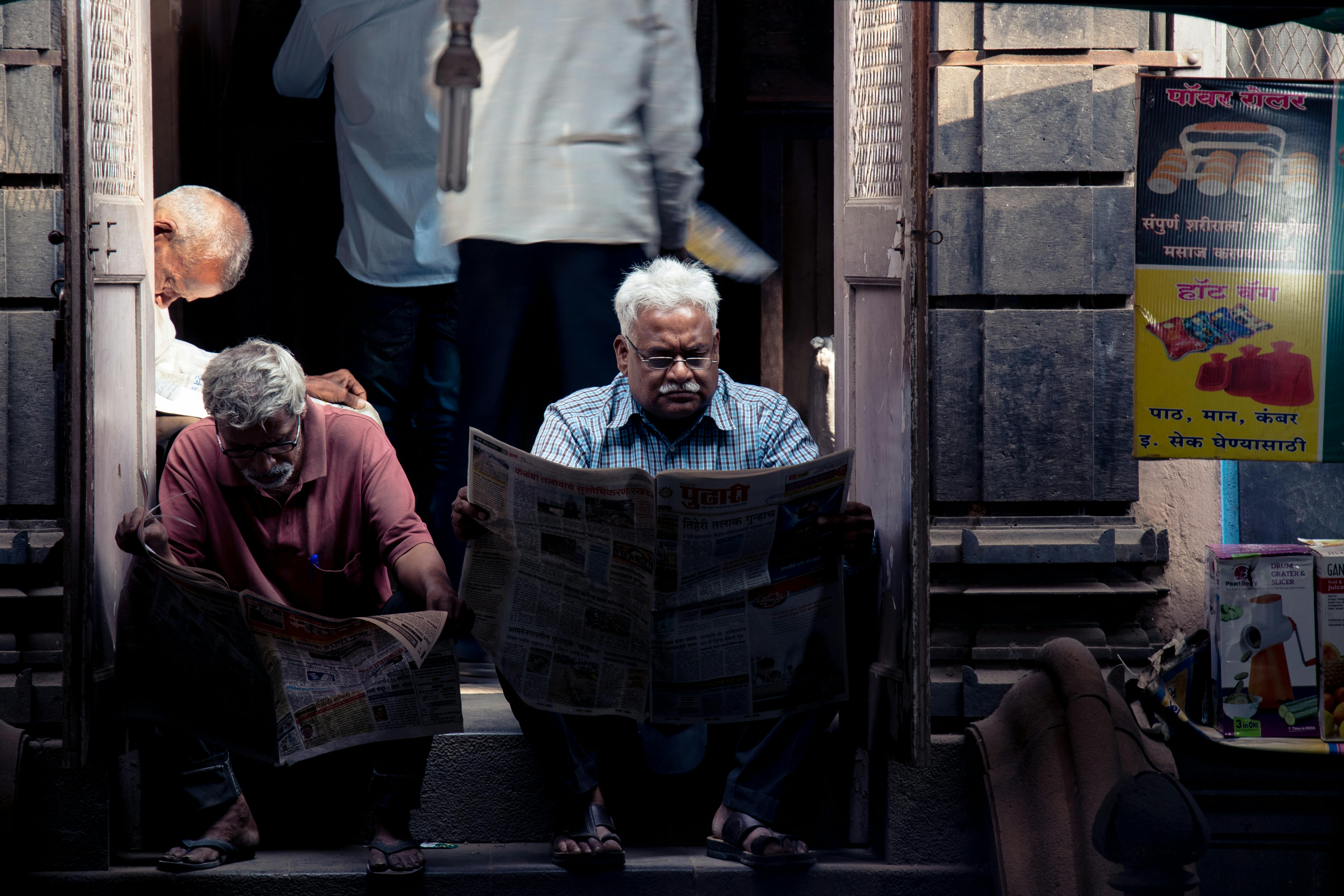 Two Men Reading Newspaper · Free Stock Photo