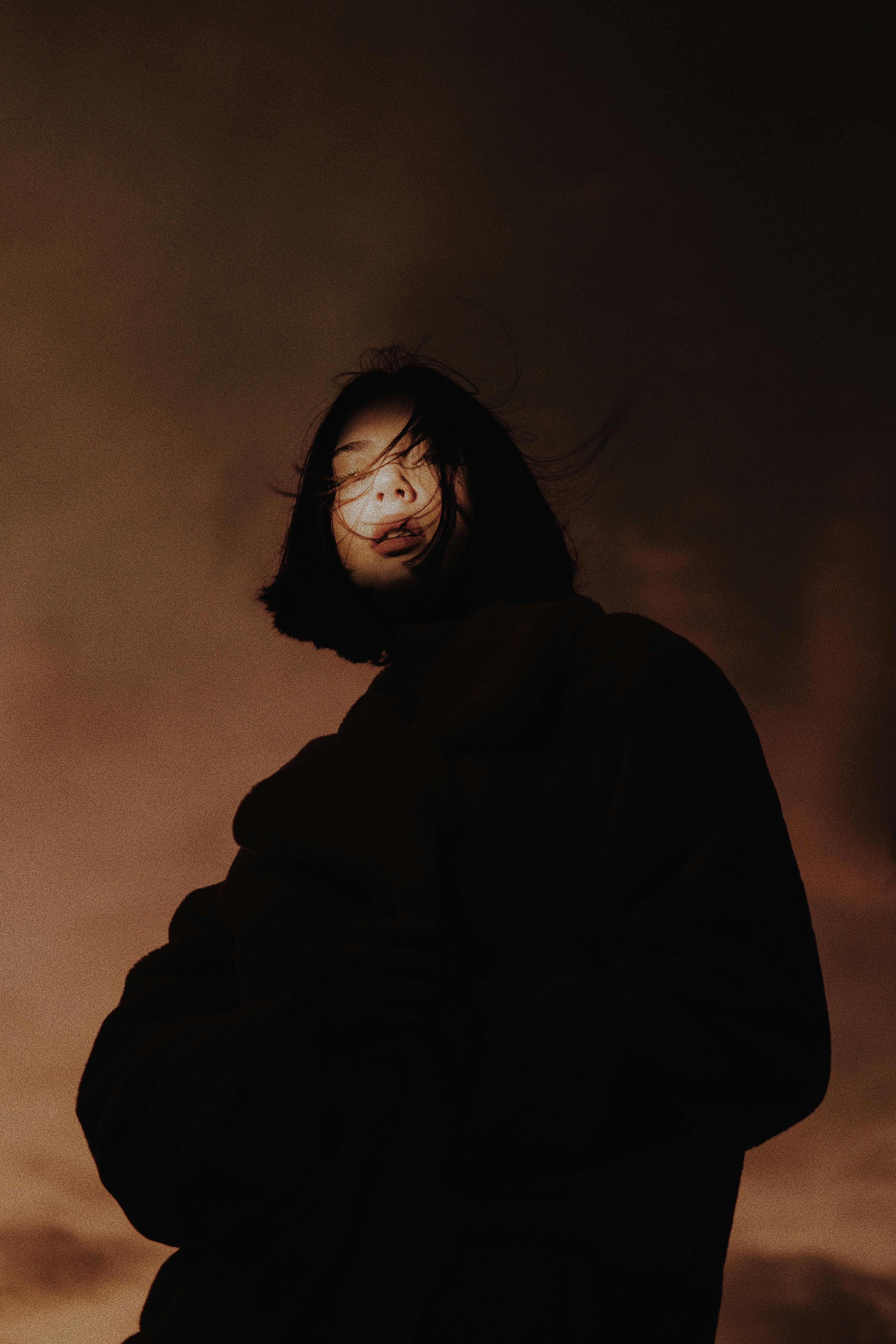 Woman Standing at Dusk · Free Stock Photo