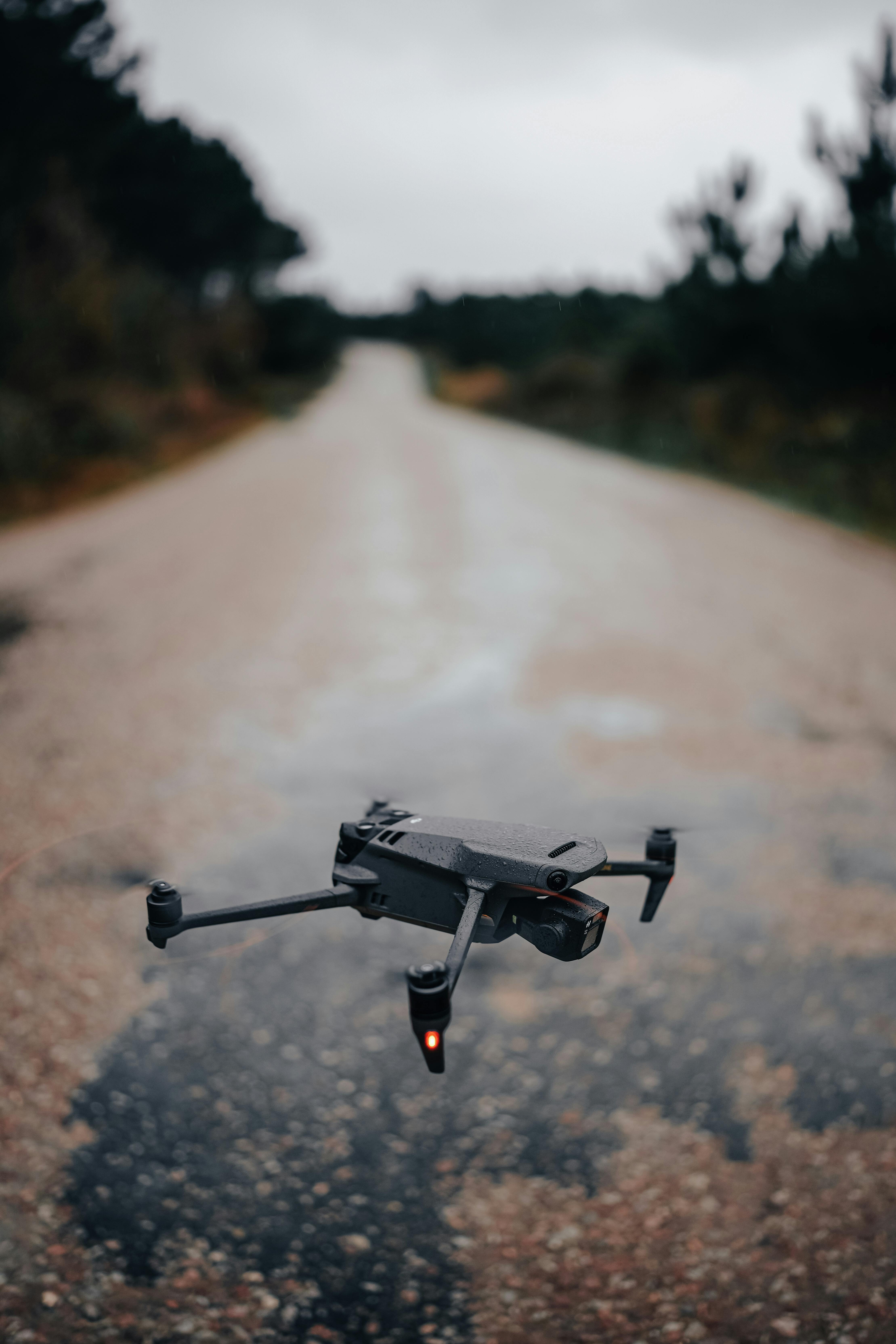 Drone Hovering over an Empty Country Road · Free Stock Photo