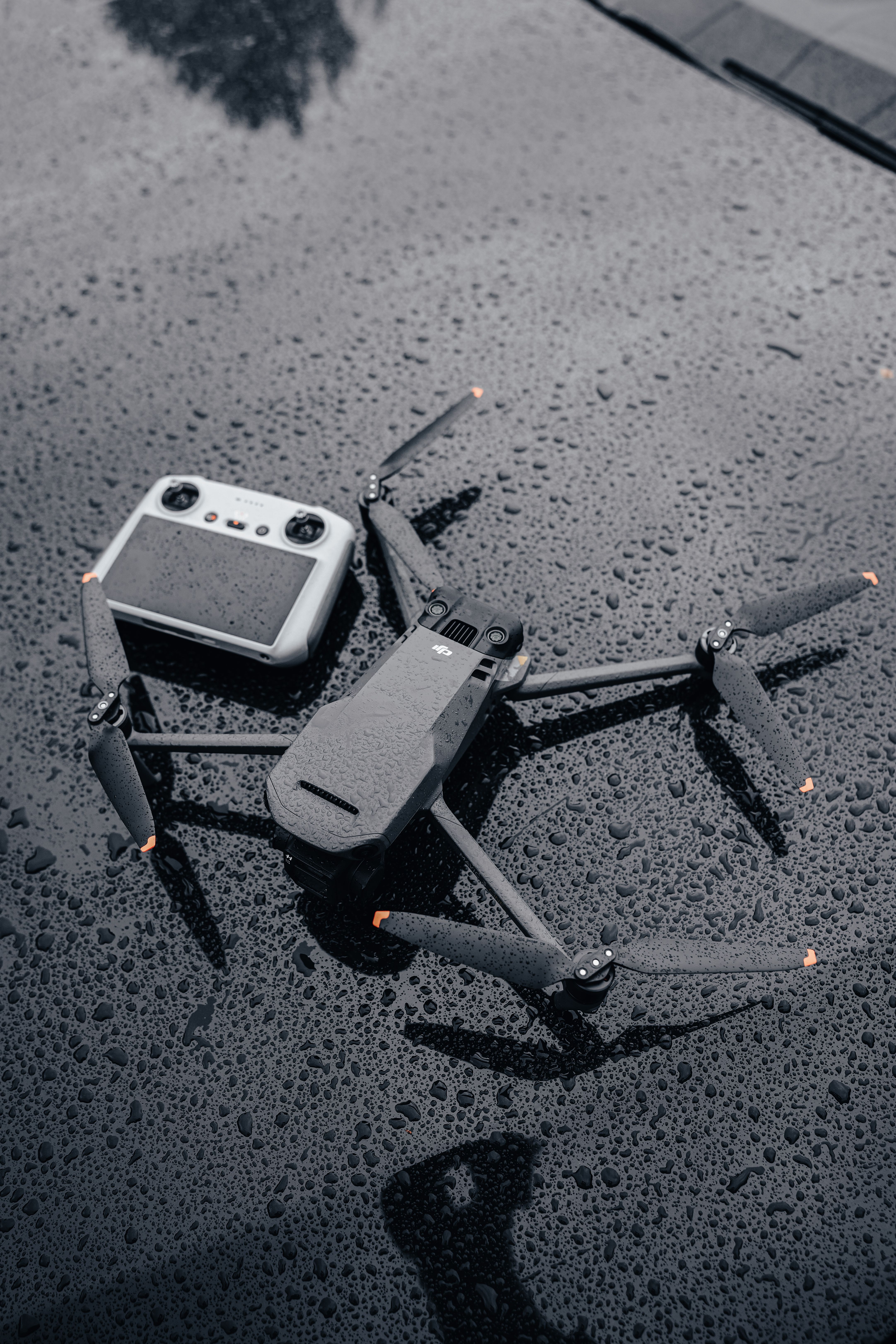Drone and Controller on Wet Surface · Free Stock Photo