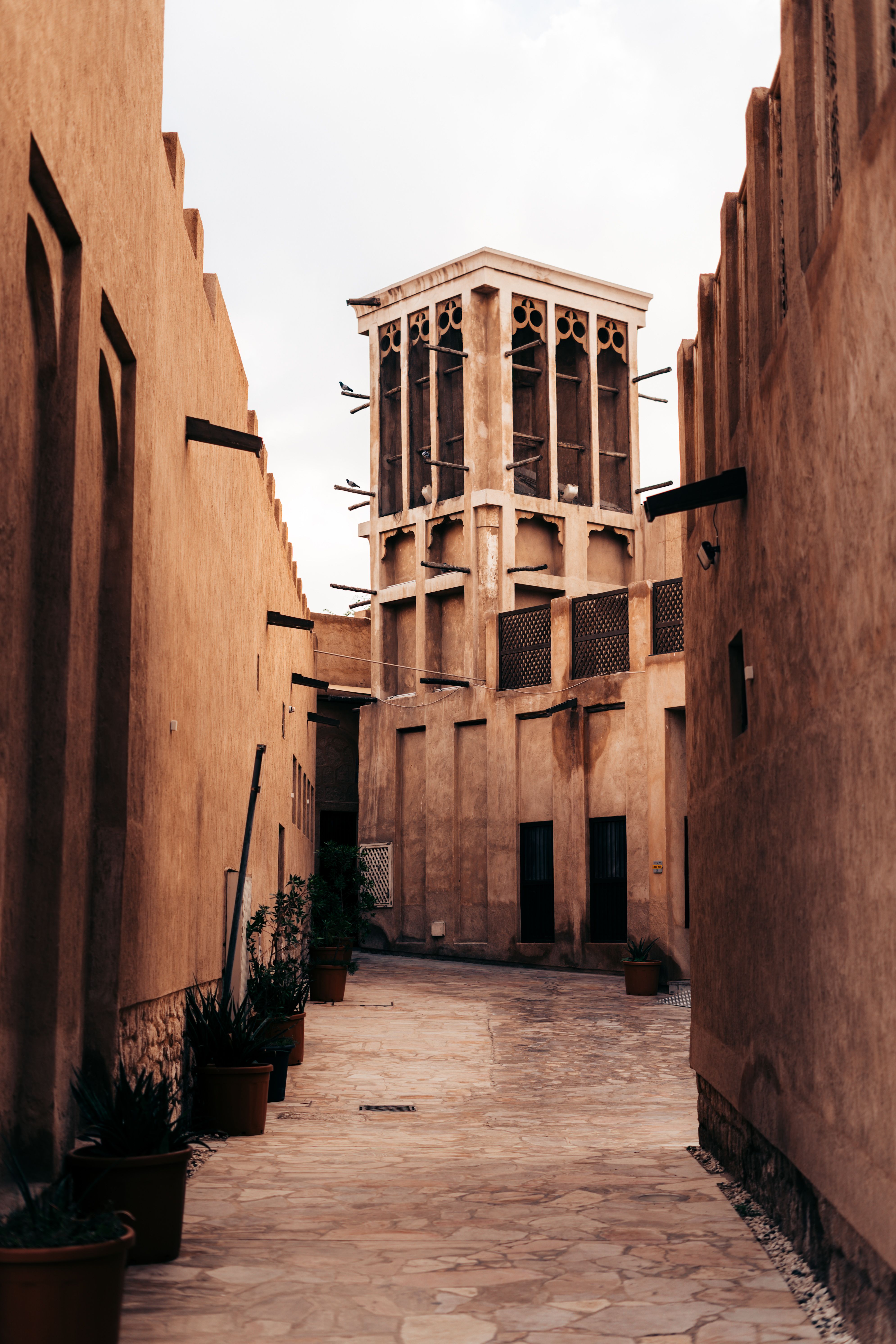 Buildings and Tower around Empty Alley · Free Stock Photo