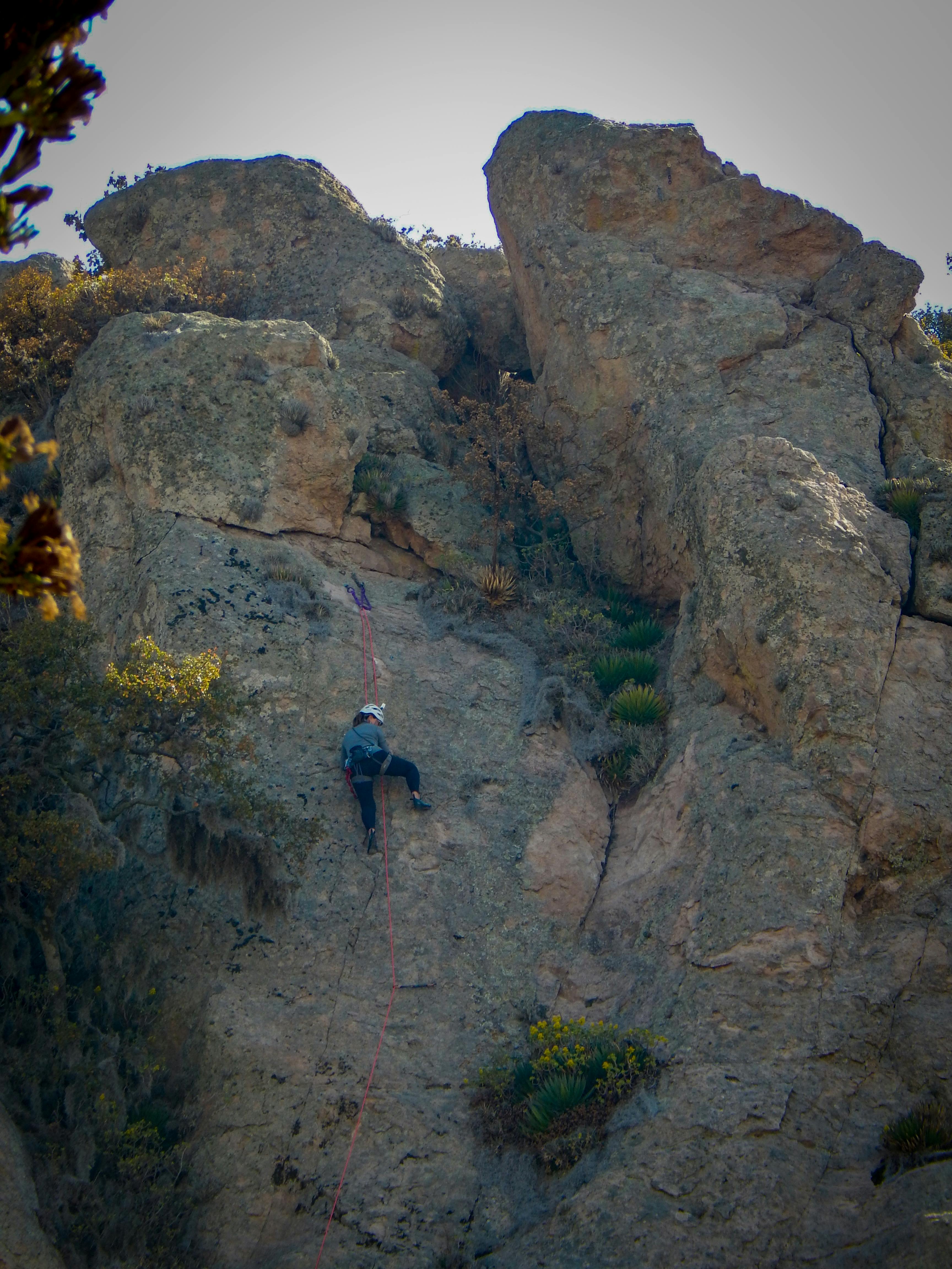 Person Climbing on Rock Mountain · Free Stock Photo