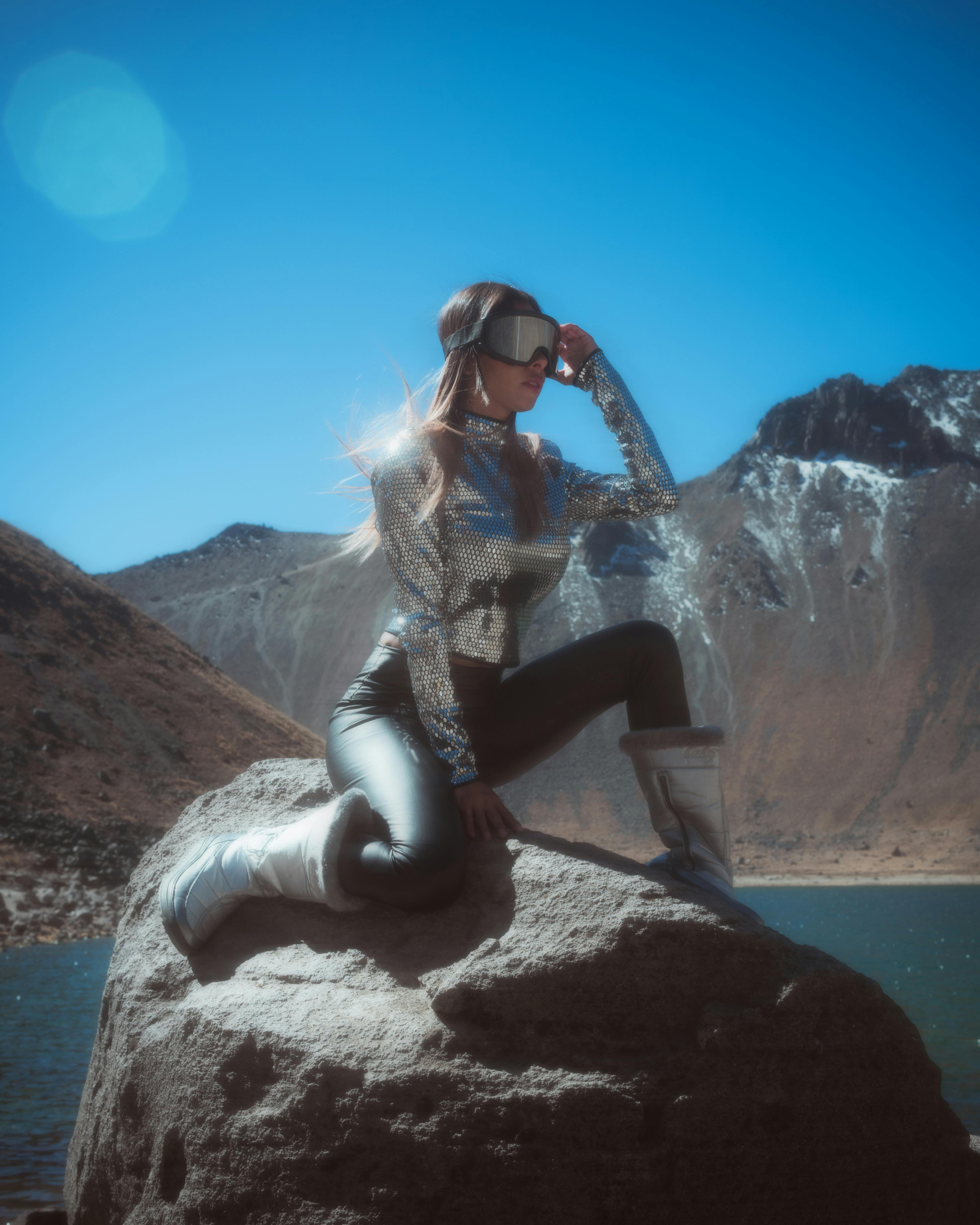 A Fashionable Woman Posing on a Big Rock · Free Stock Photo