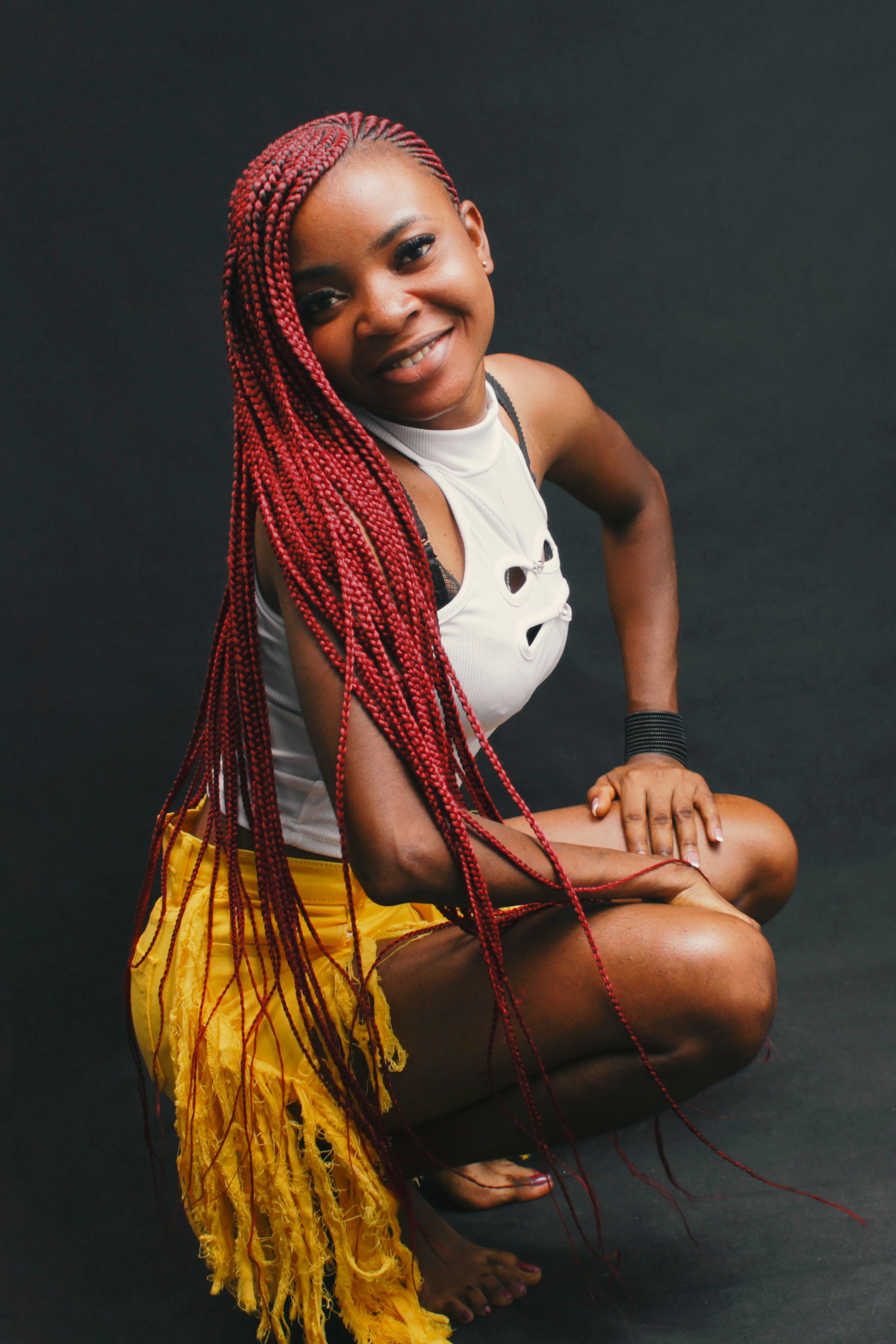 African Woman with Pink Hair Posing in a Studio · Free Stock Photo