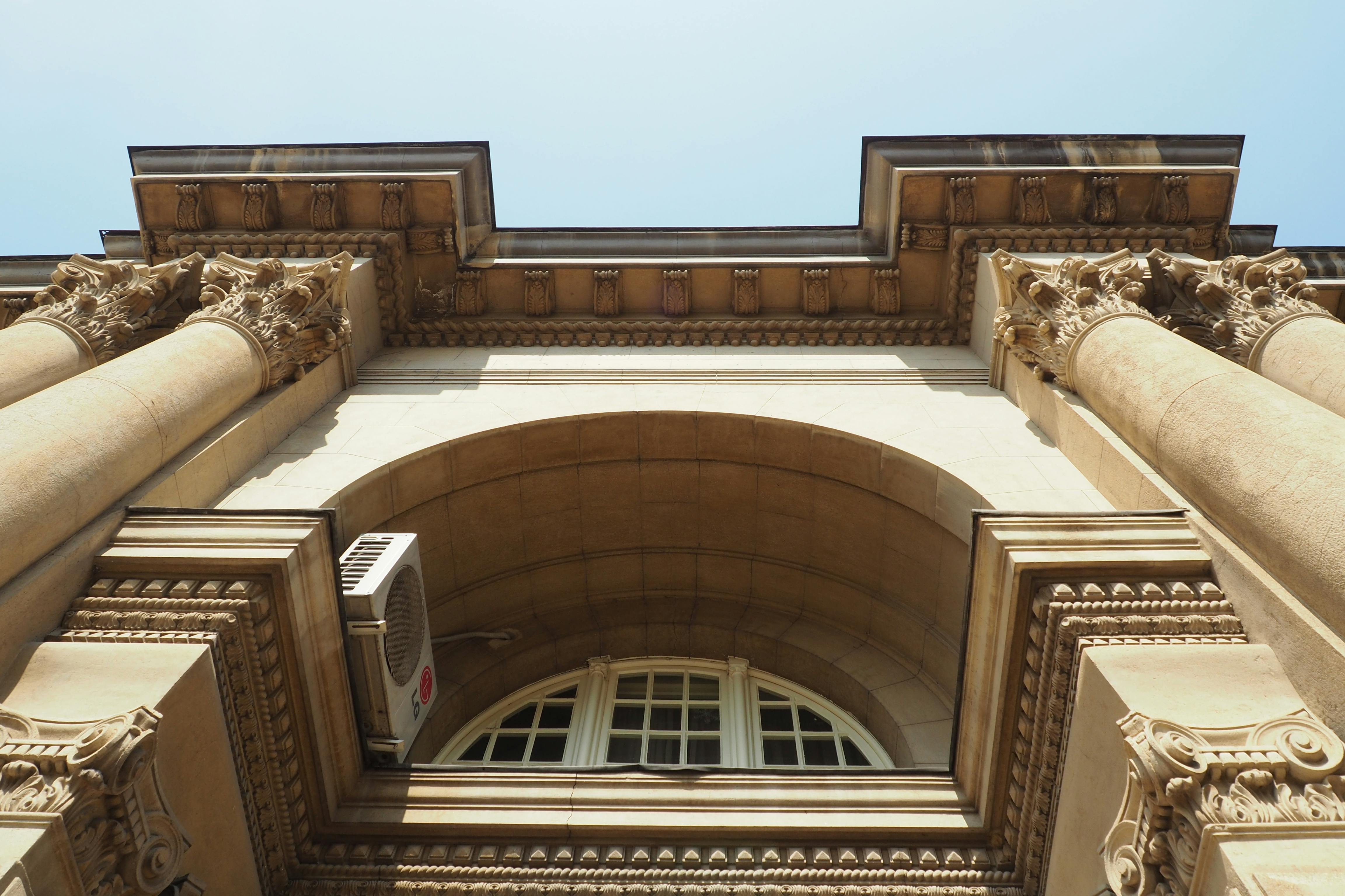 Air Conditioner on Building Wall with Columns · Free Stock Photo