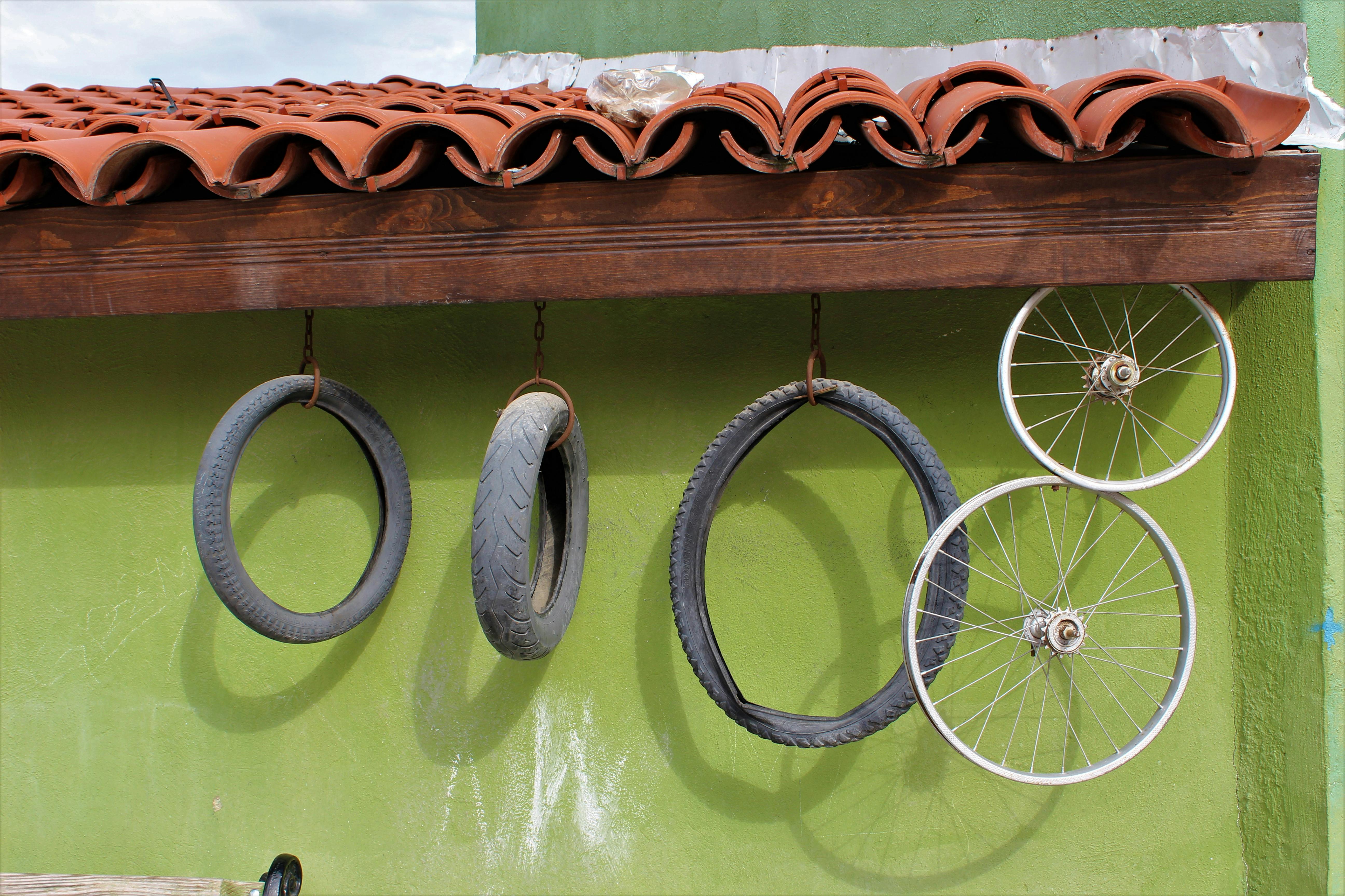 Tyres and Wheels Hanging on Wall · Free Stock Photo