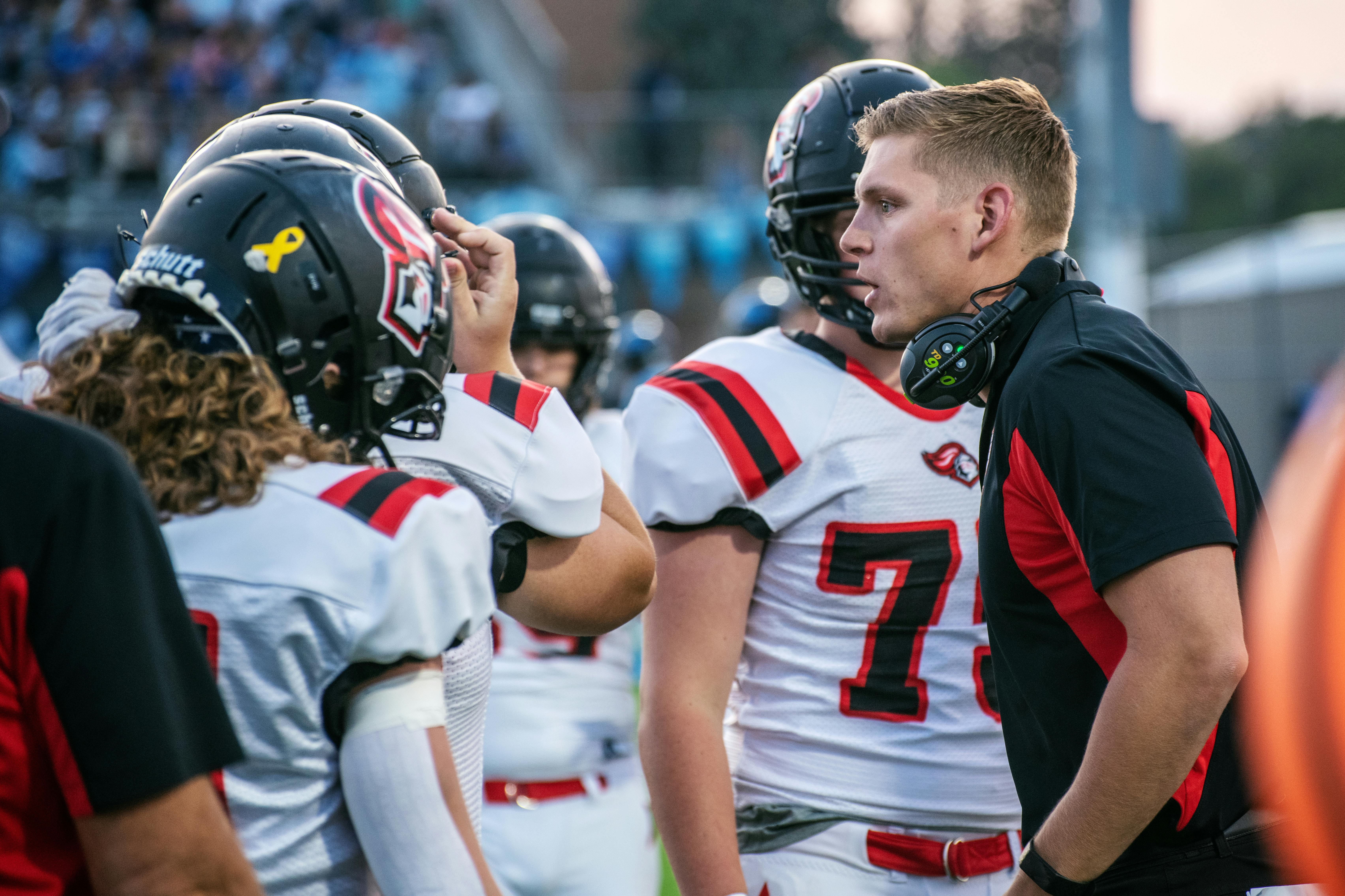 Coach with Players in Stadium · Free Stock Photo