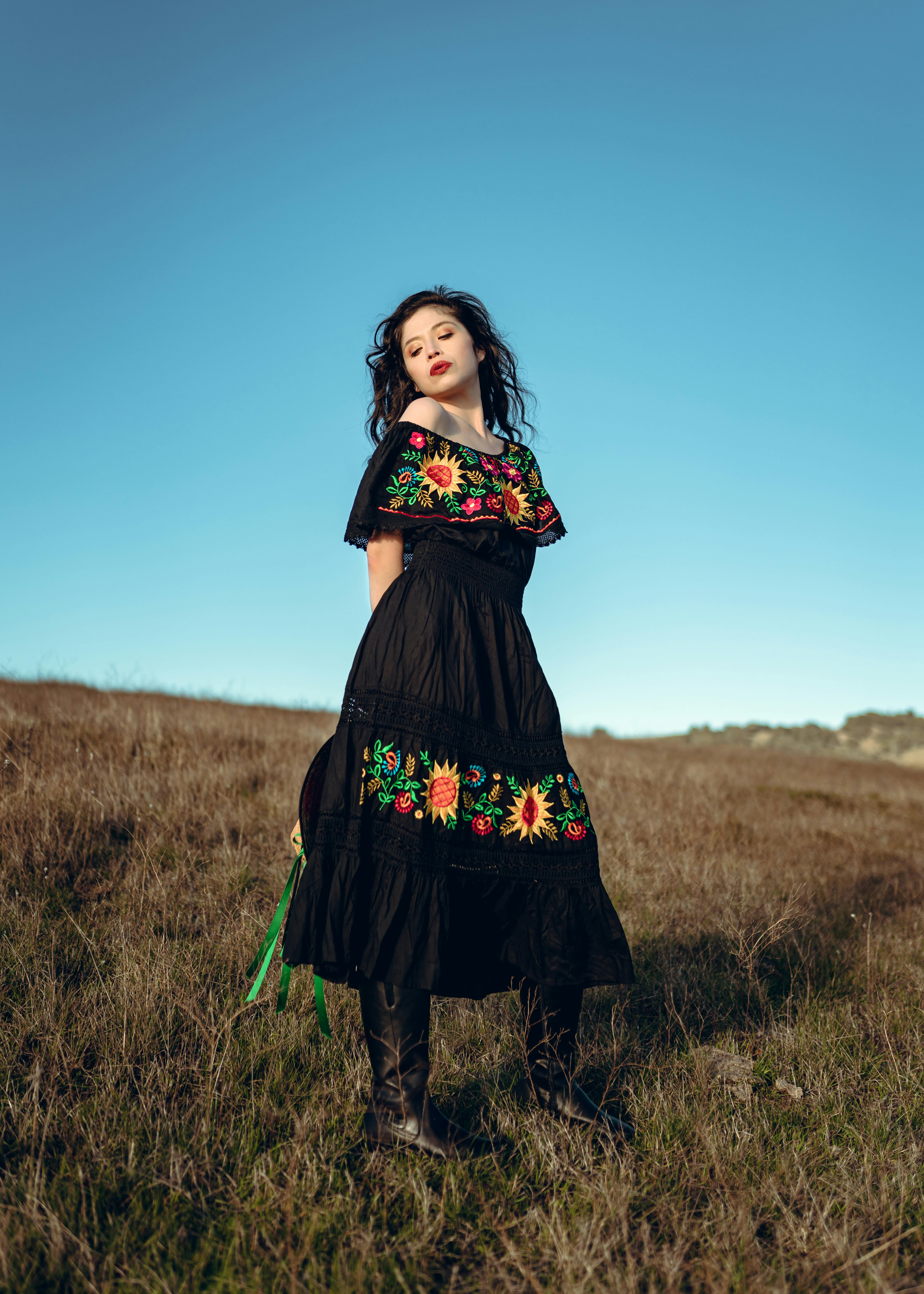 Woman in Black Dress Standing on Grass · Free Stock Photo