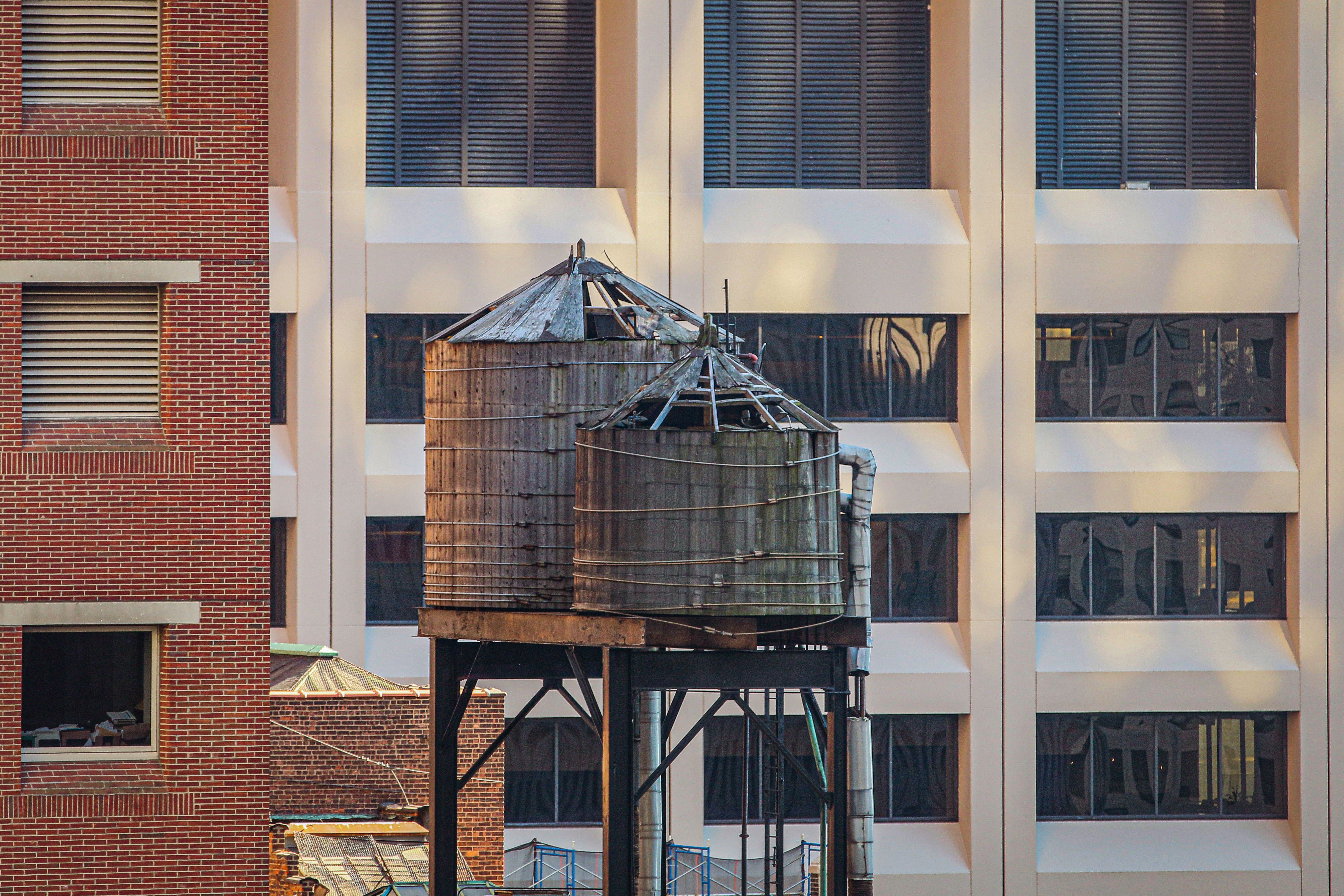 Broken Water Towers on Rooftop · Free Stock Photo