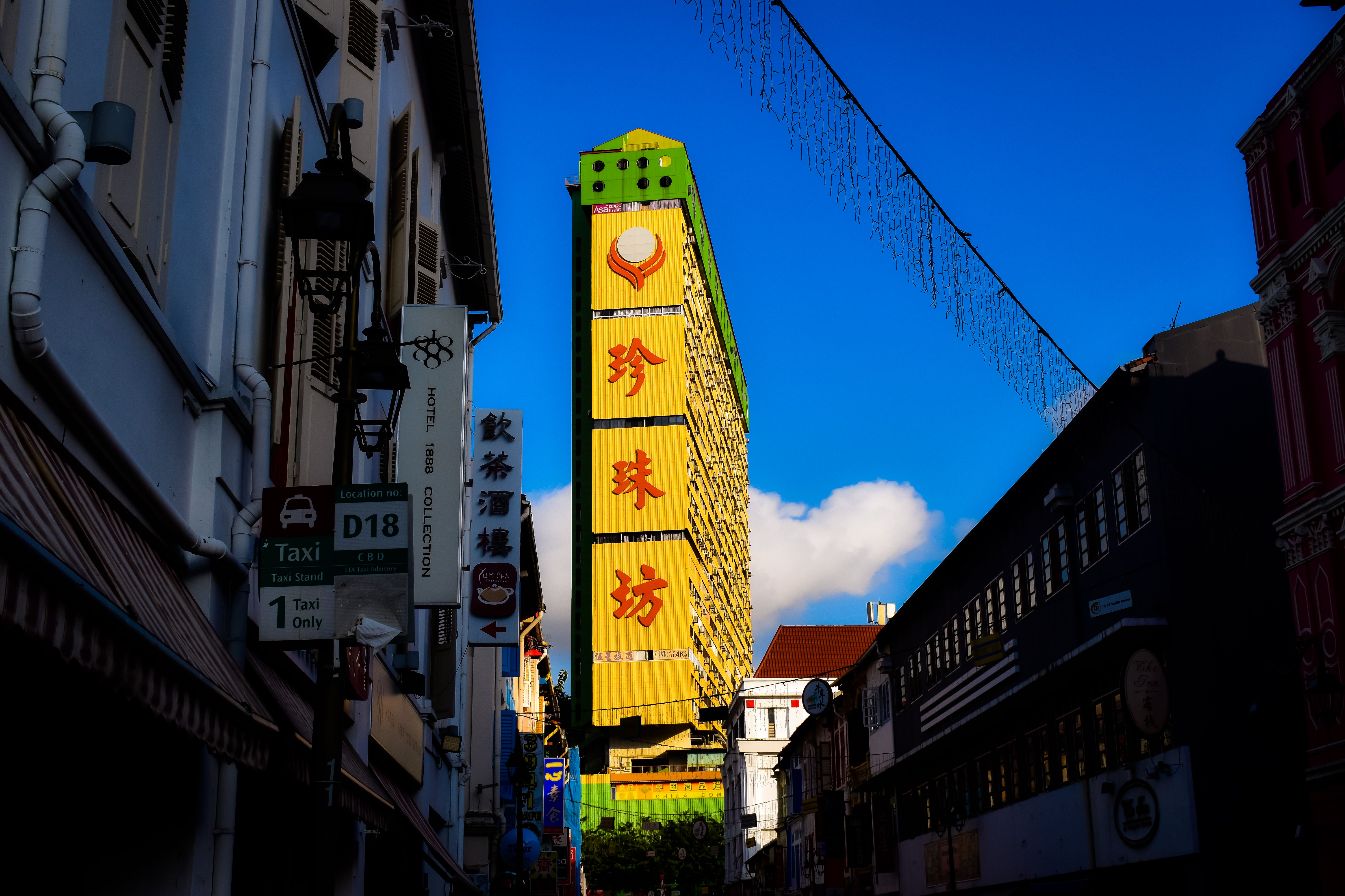 Yellow Mural among Buildings in Singapore · Free Stock Photo