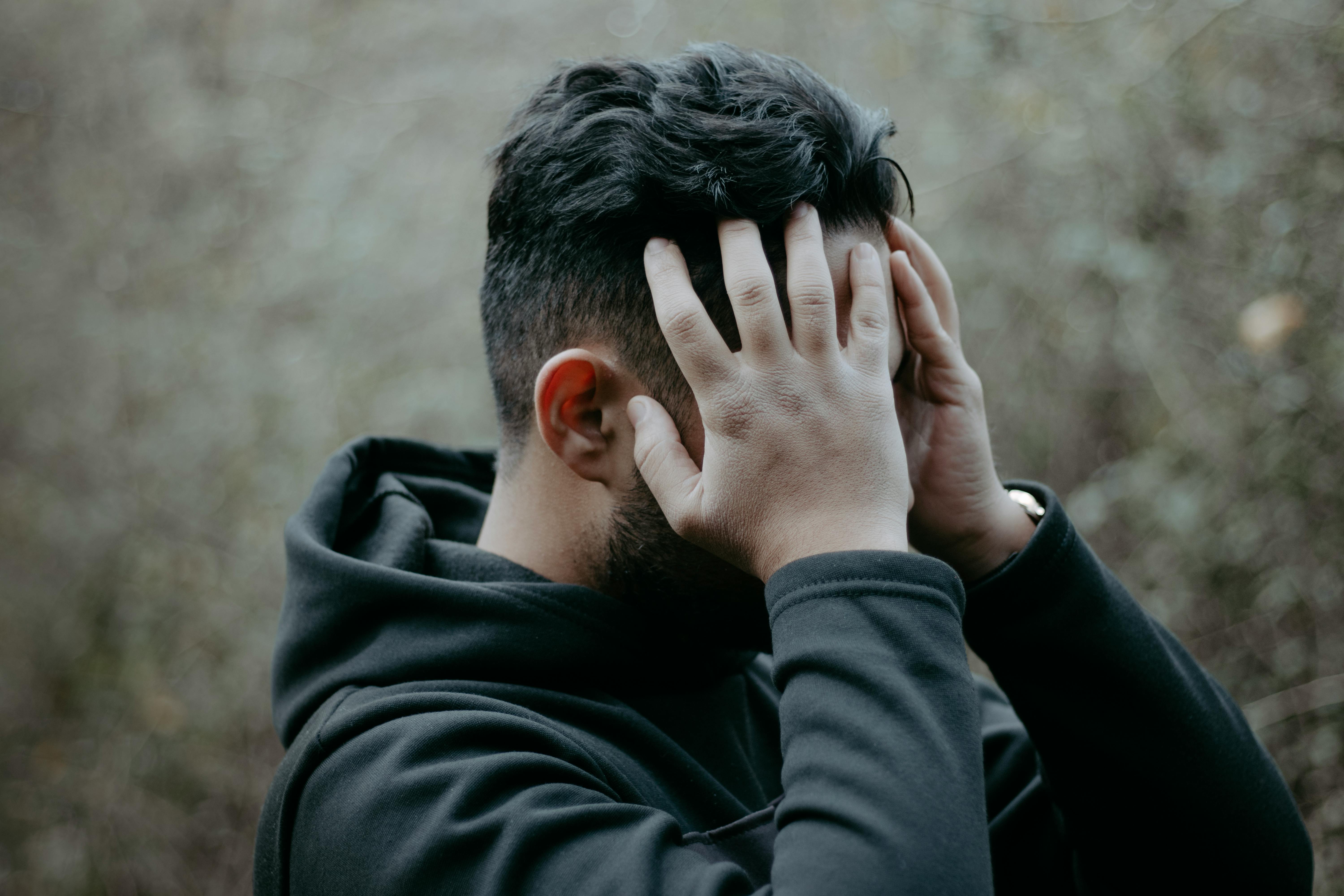 A Man Holding his Head · Free Stock Photo