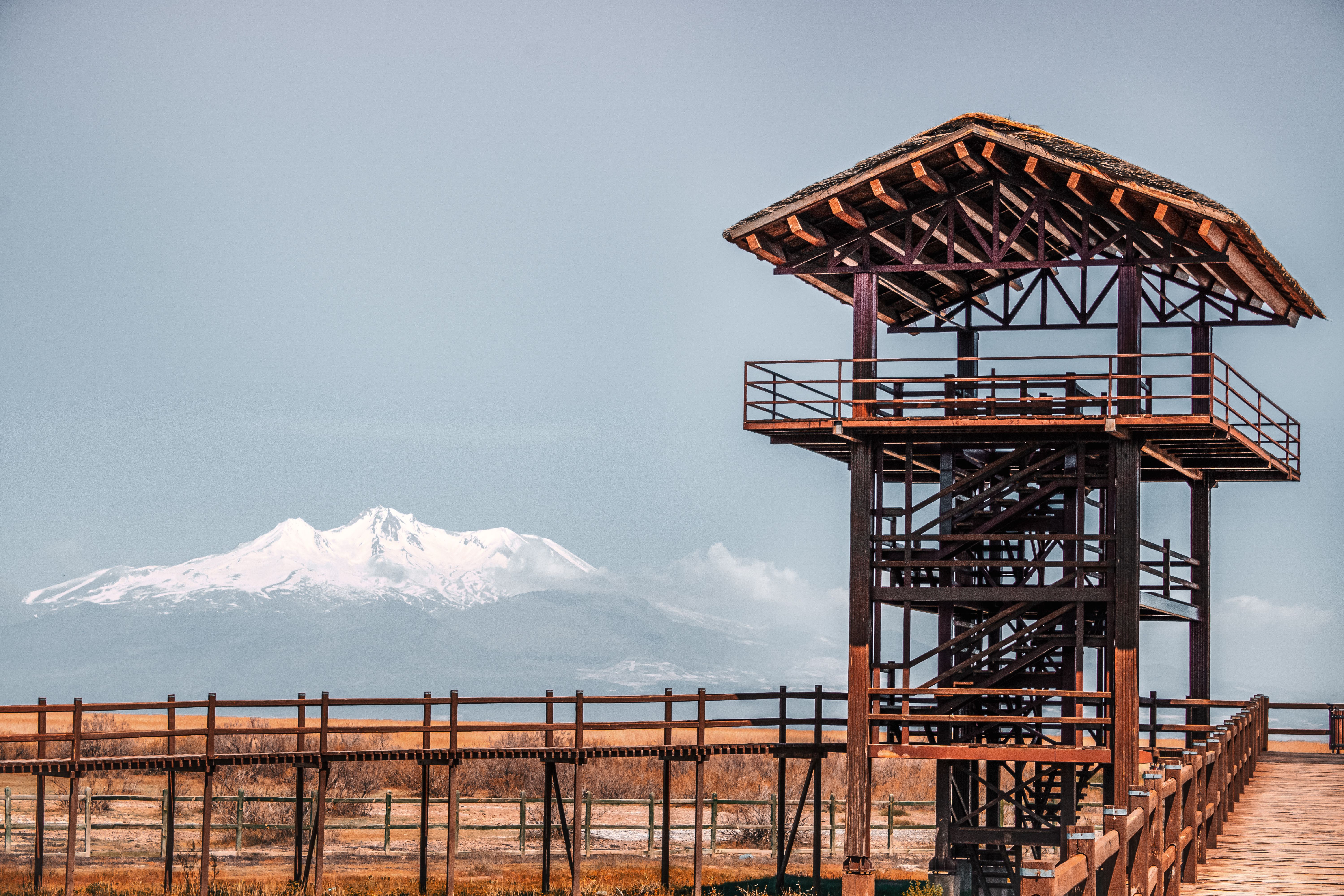 Wooden Tower with Mountain behind · Free Stock Photo