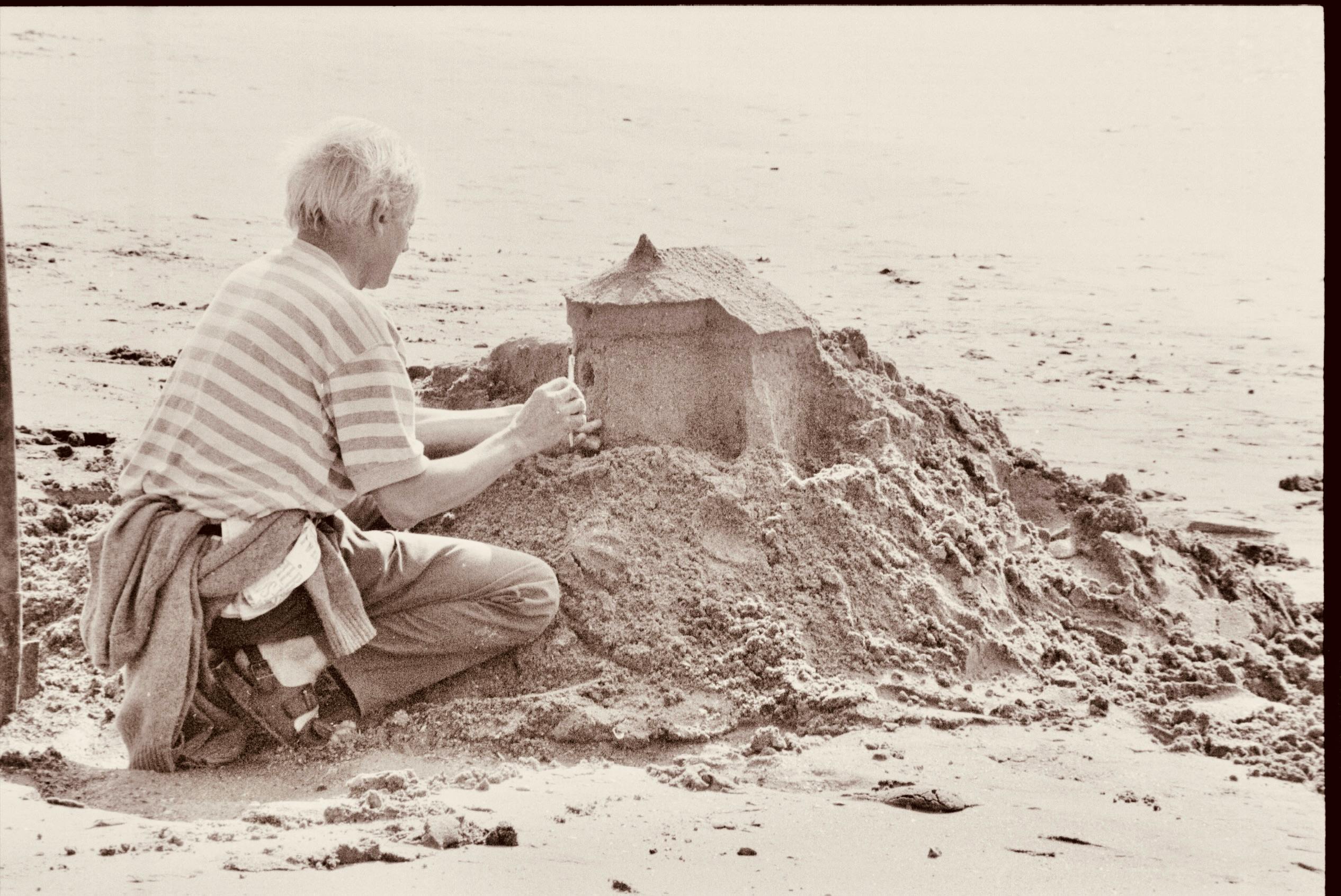 Man Building Sand Castle · Free Stock Photo