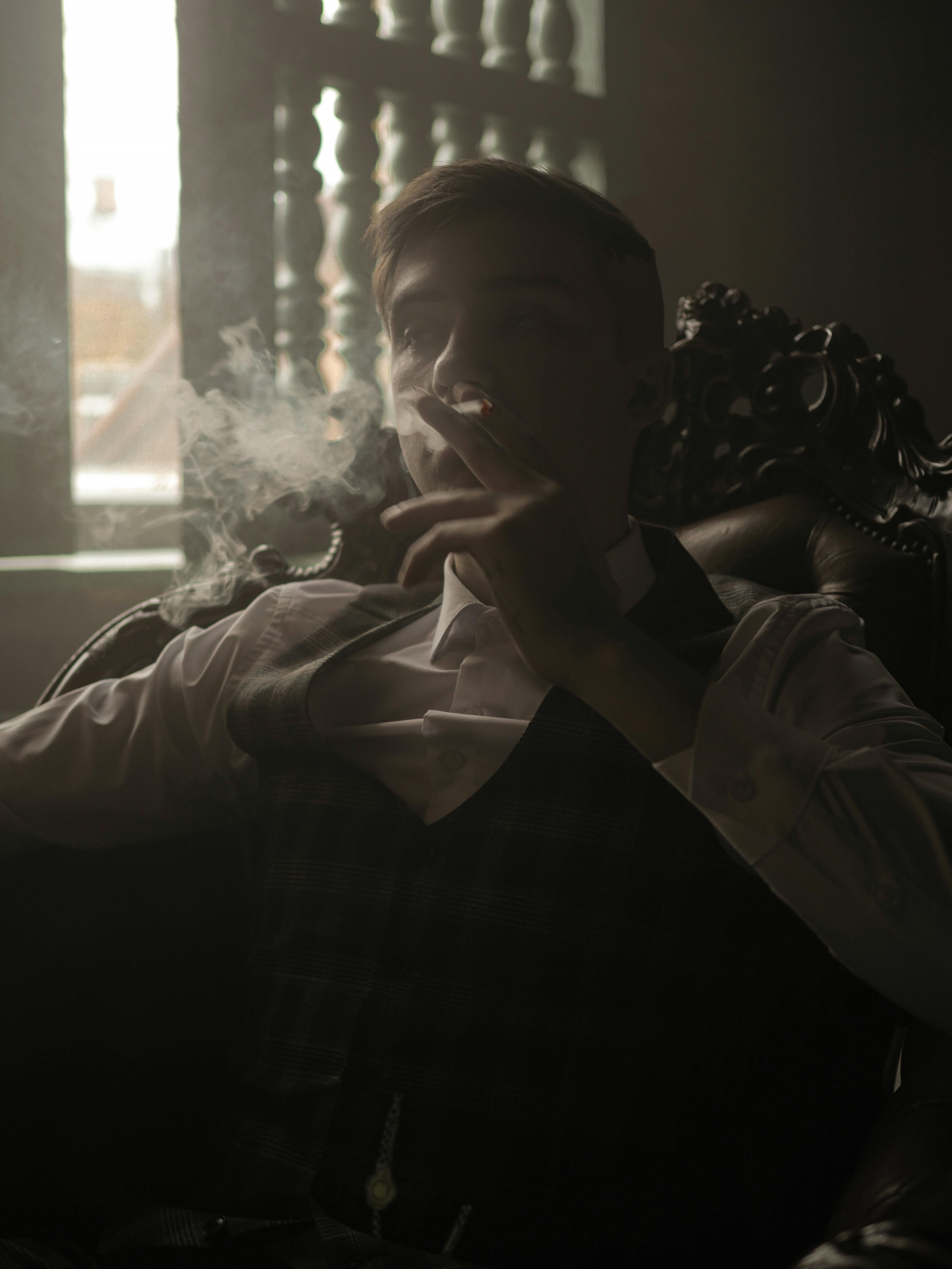 Man Sitting and Smoking · Free Stock Photo