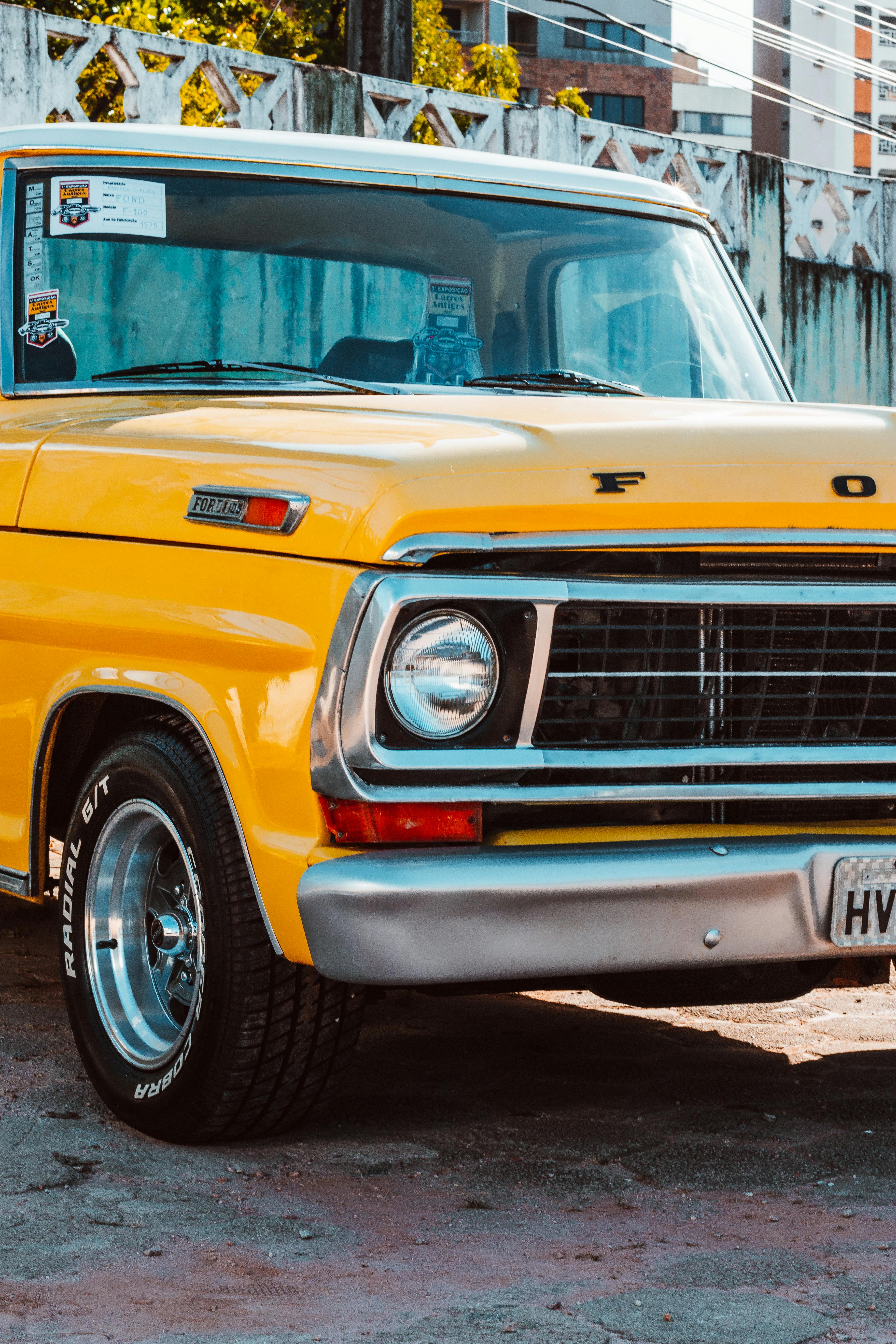 A Yellow Ford Truck on a Parking Lot · Free Stock Photo