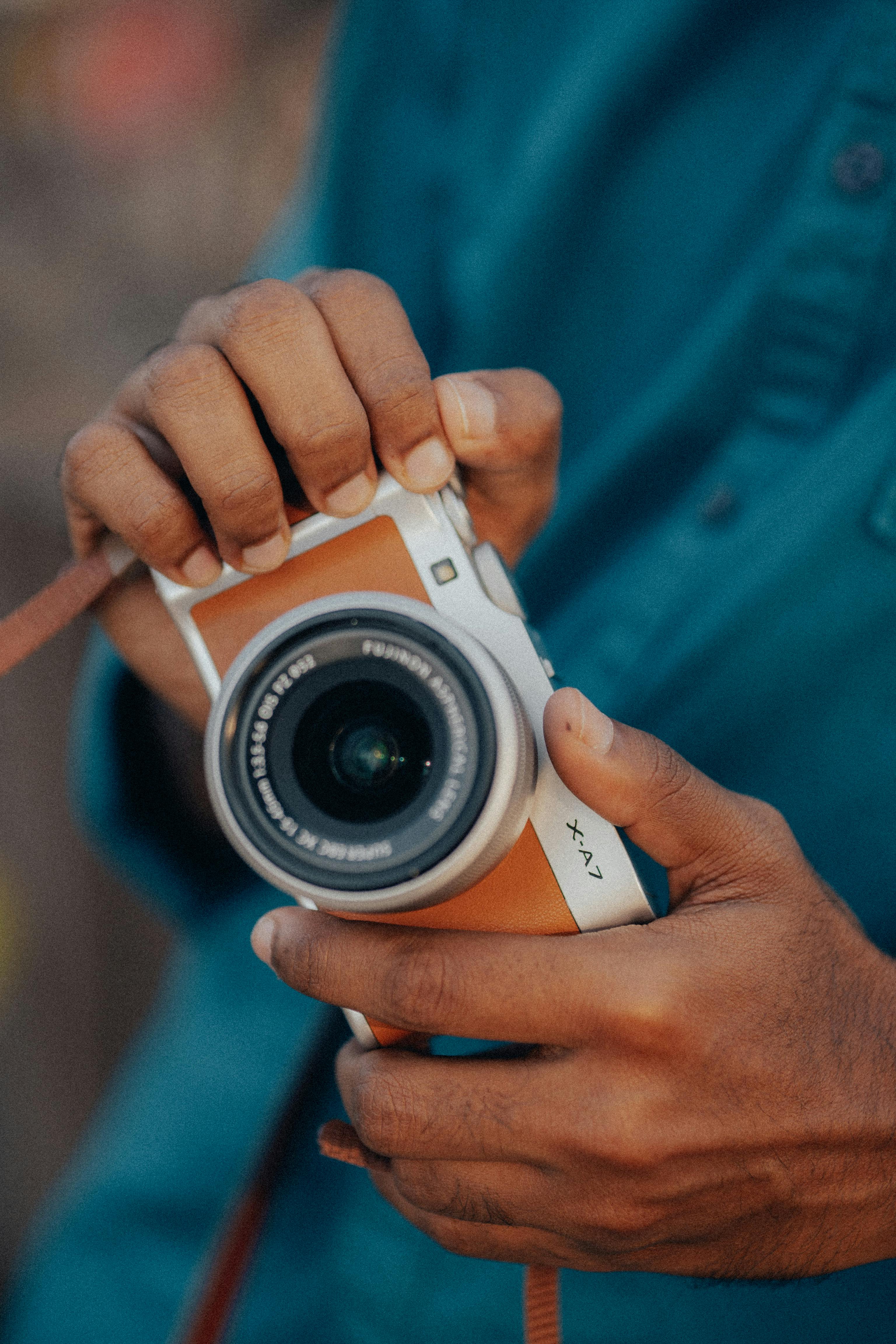A Person Holding a Black and Silver Camera · Free Stock Photo