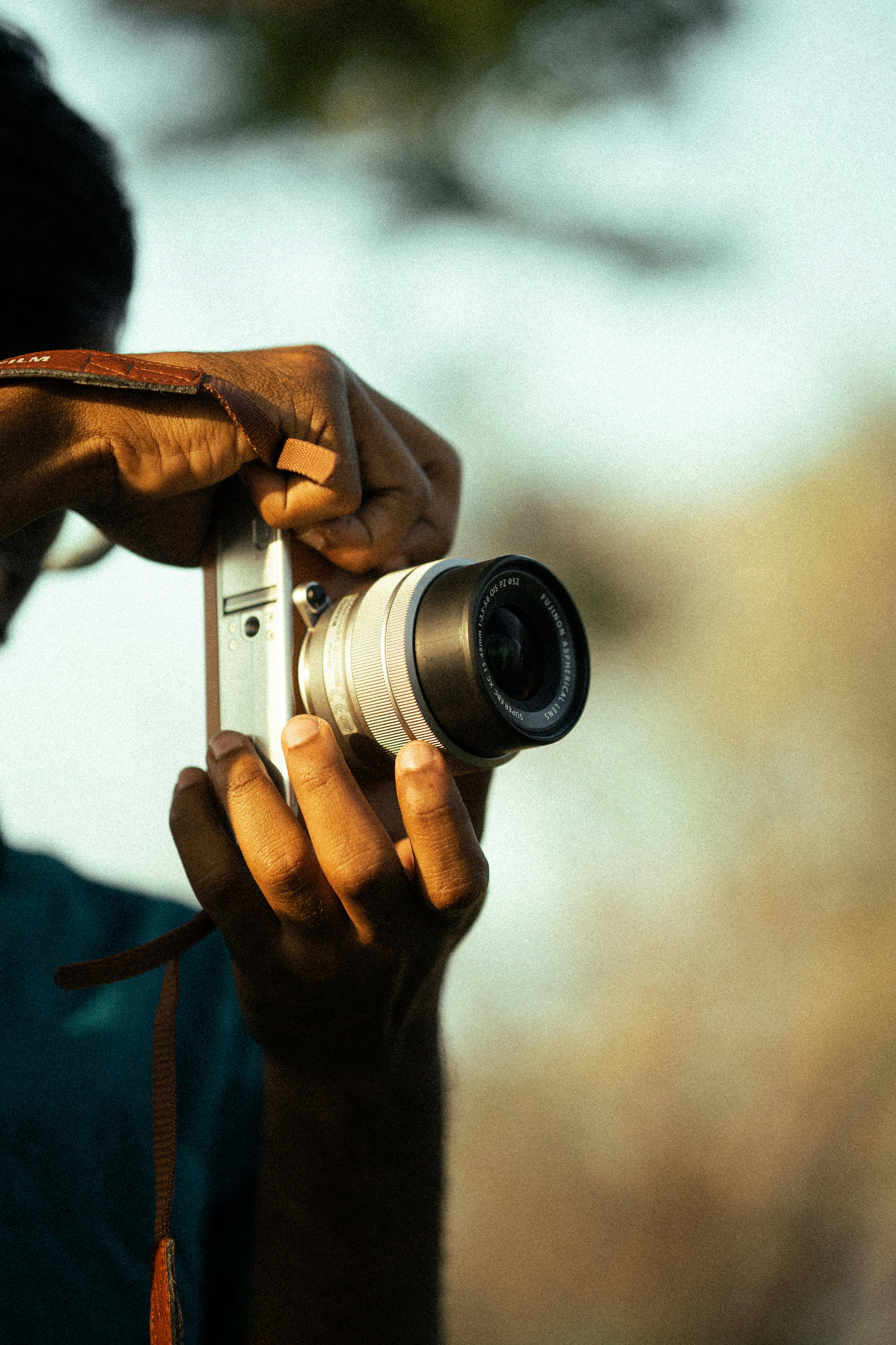 A Person Holding a Black and Silver Camera · Free Stock Photo