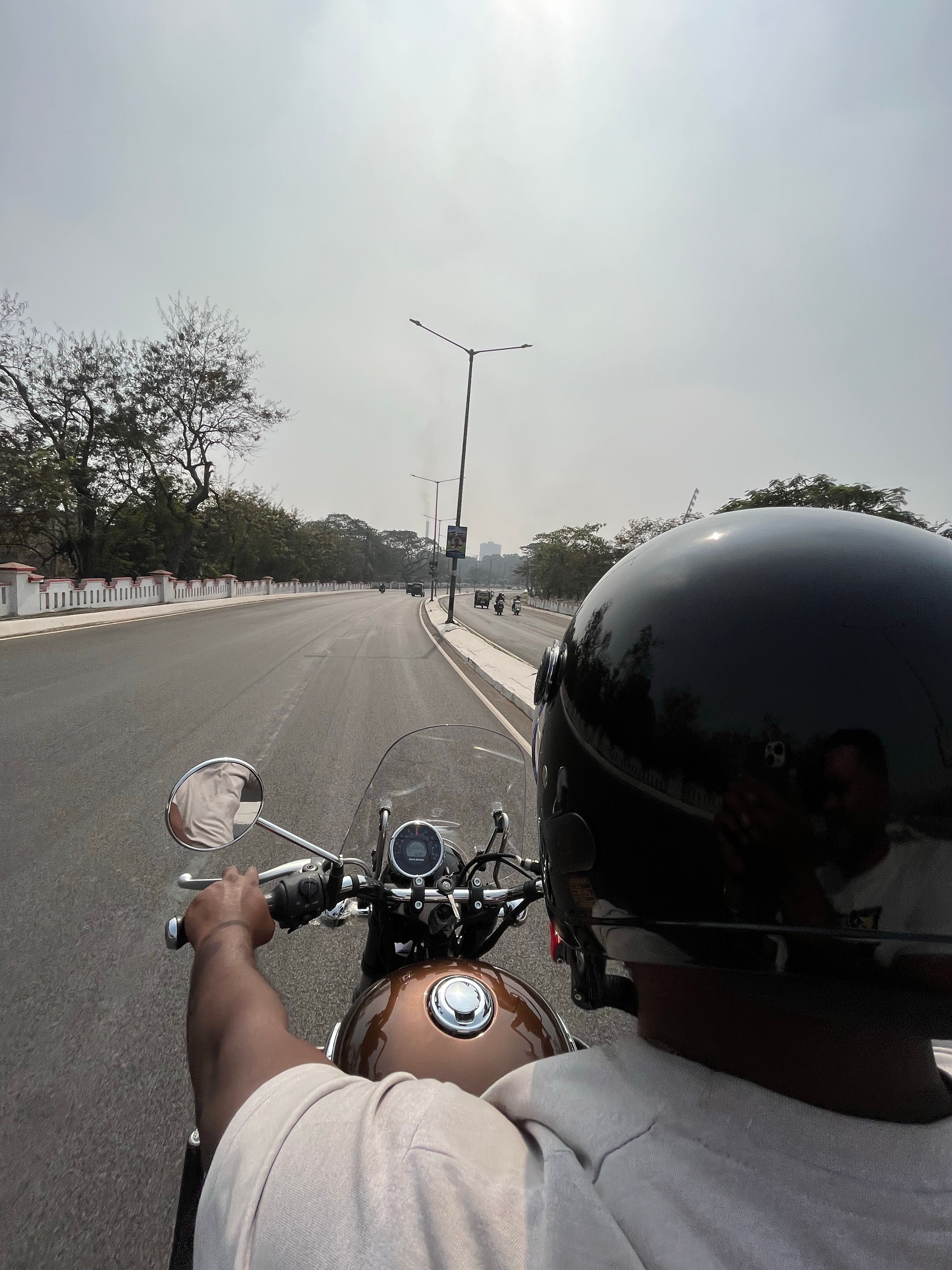 Person Riding a Motorcycle along an Asphalt Road · Free Stock Photo