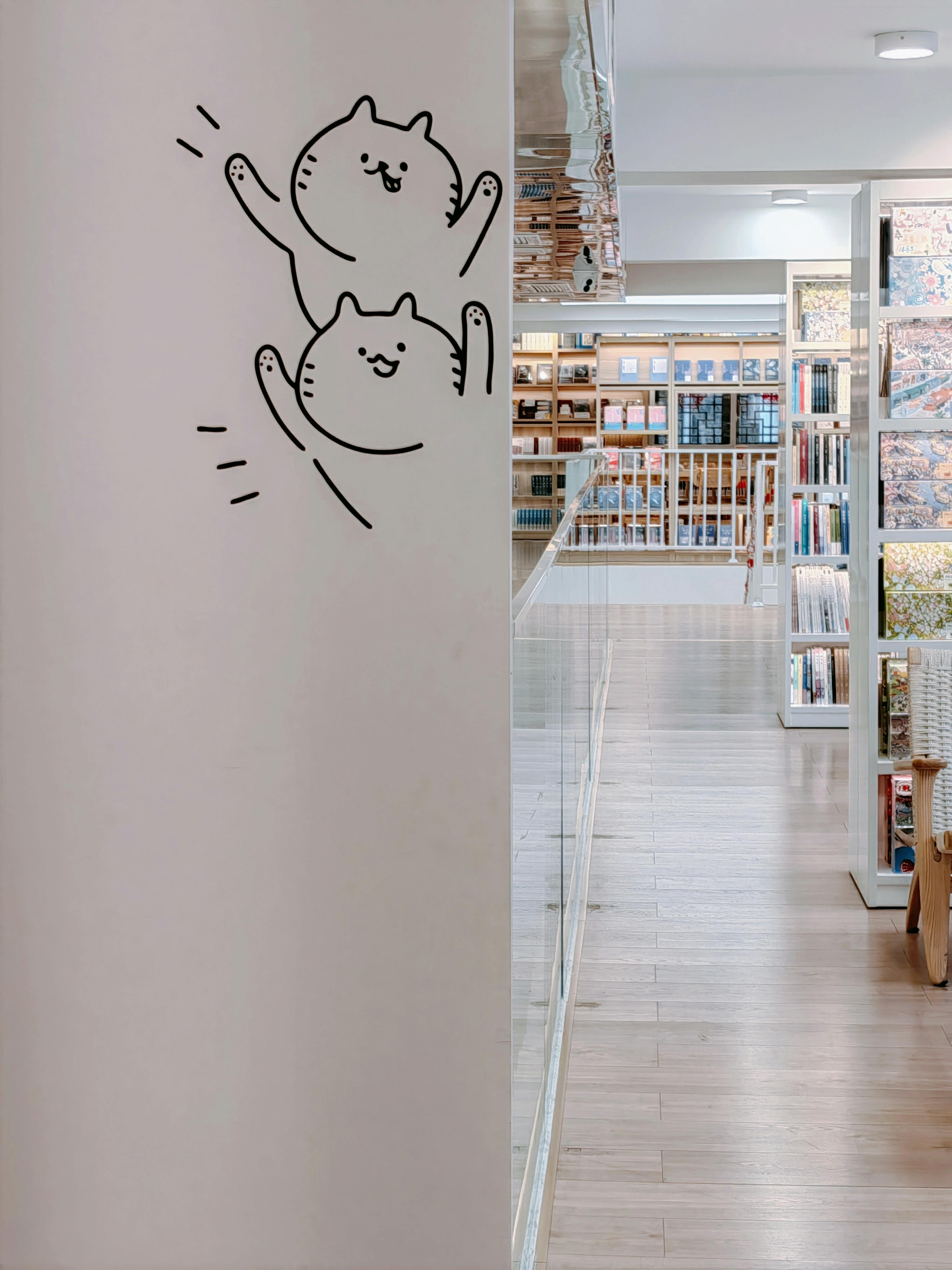 Drawings of Cats on a Wall in a Library · Free Stock Photo