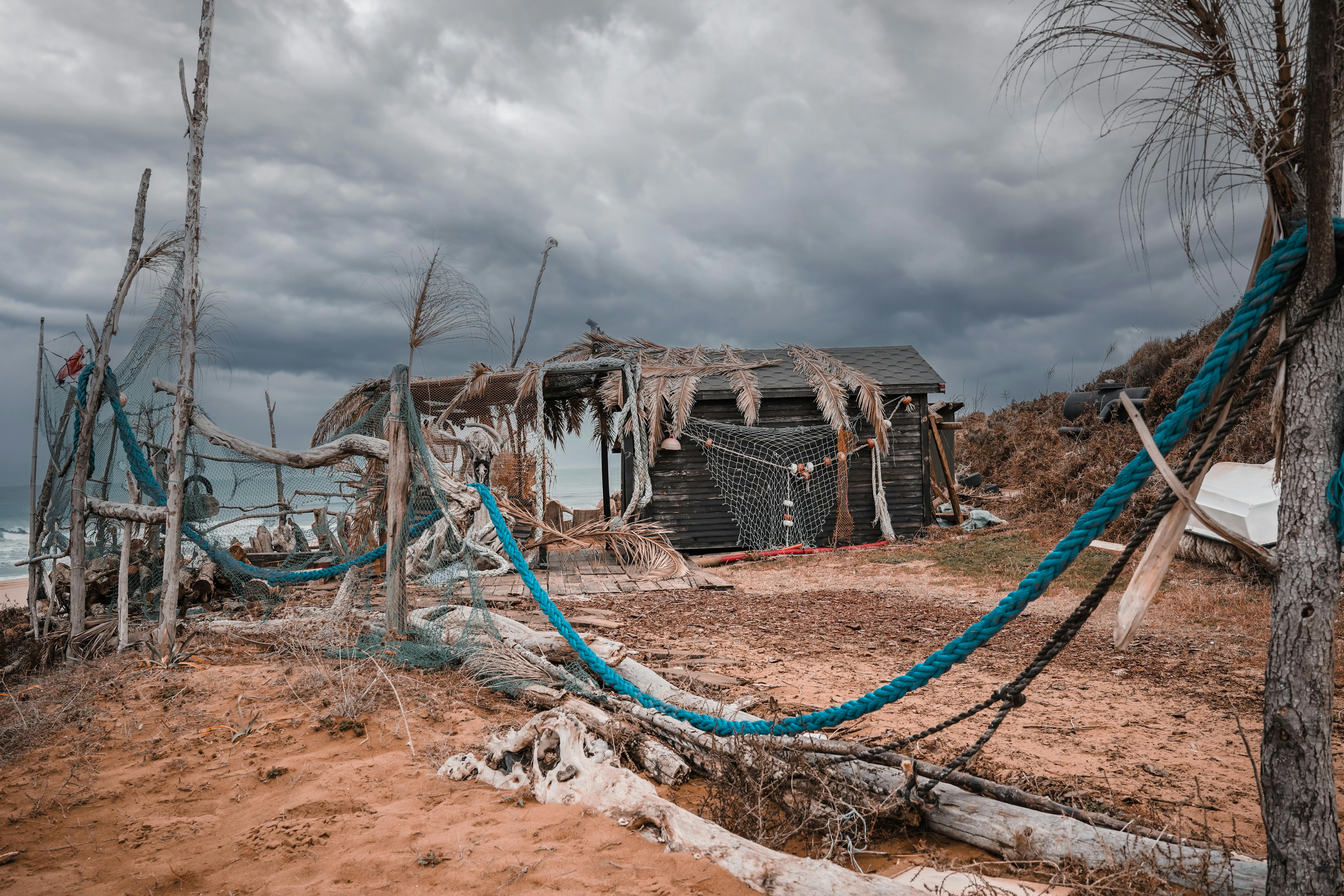 Clouds over Destroyed Hut on Sea Shore · Free Stock Photo