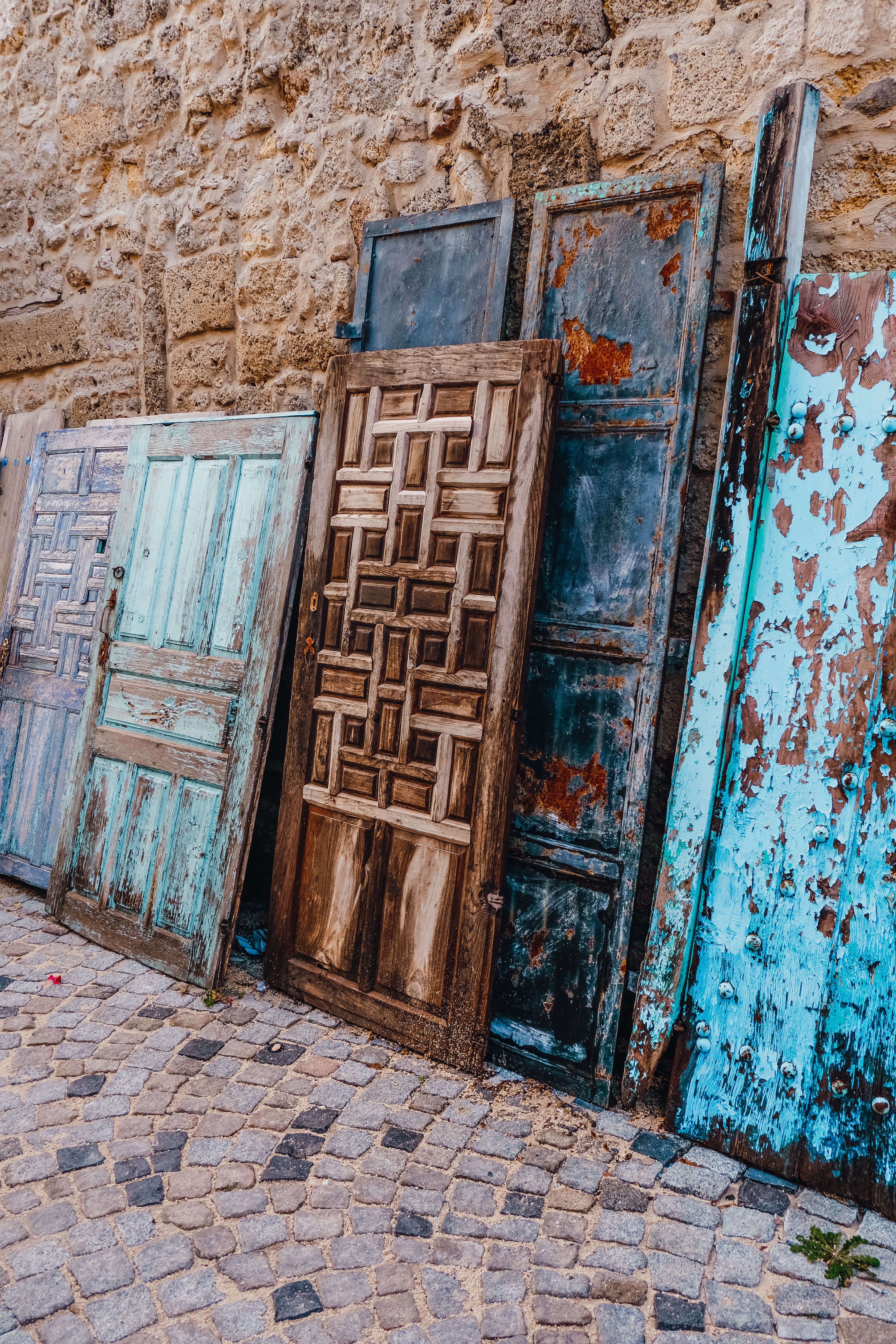 Damaged Doors Stacked by Wall · Free Stock Photo