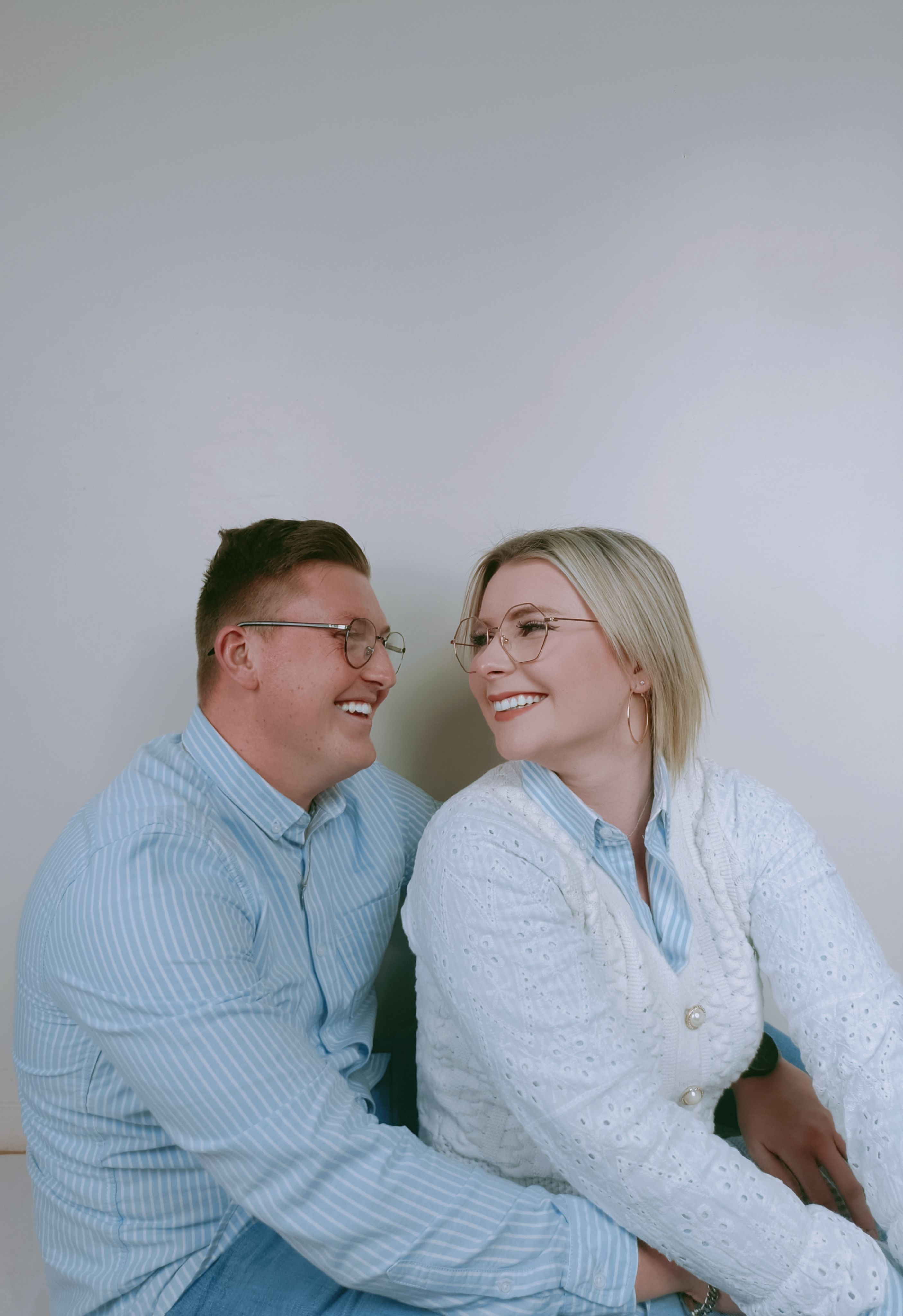 Sitting Smiling Couple Embracing · Free Stock Photo