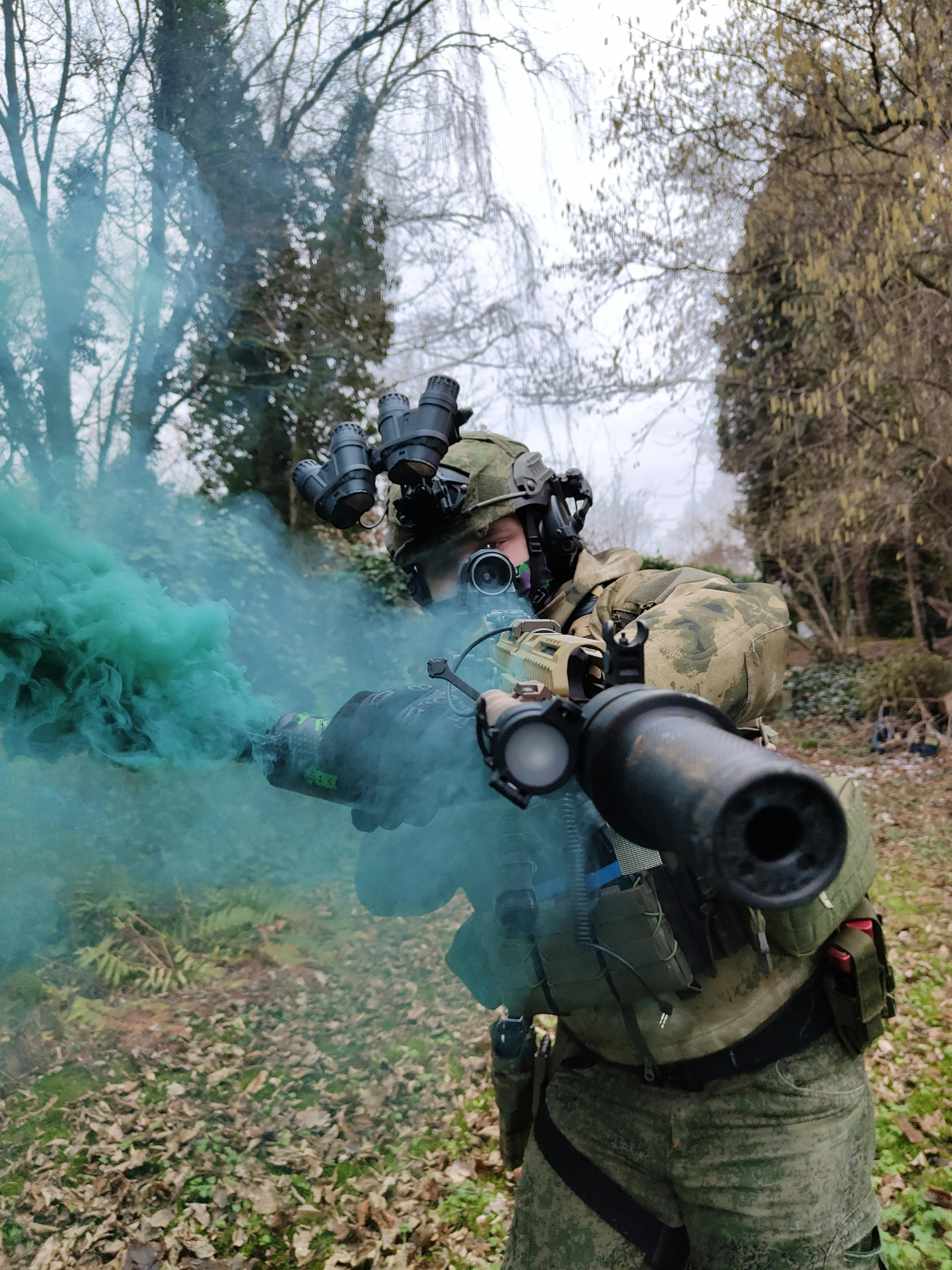 Man Launching Grenade Emitting Blue Smoke · Free Stock Photo