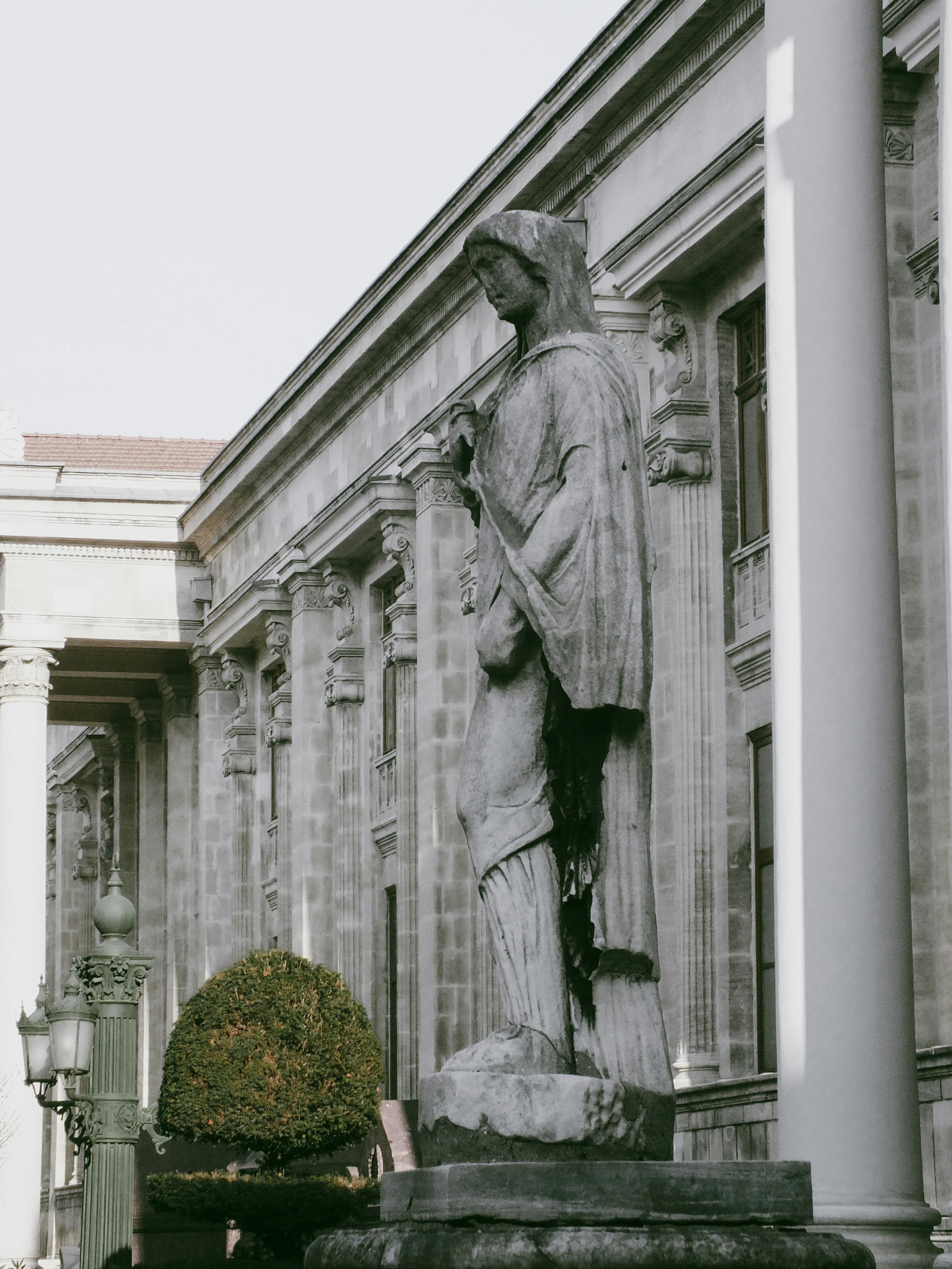 Large Stone Statue in Front of Building Facade · Free Stock Photo