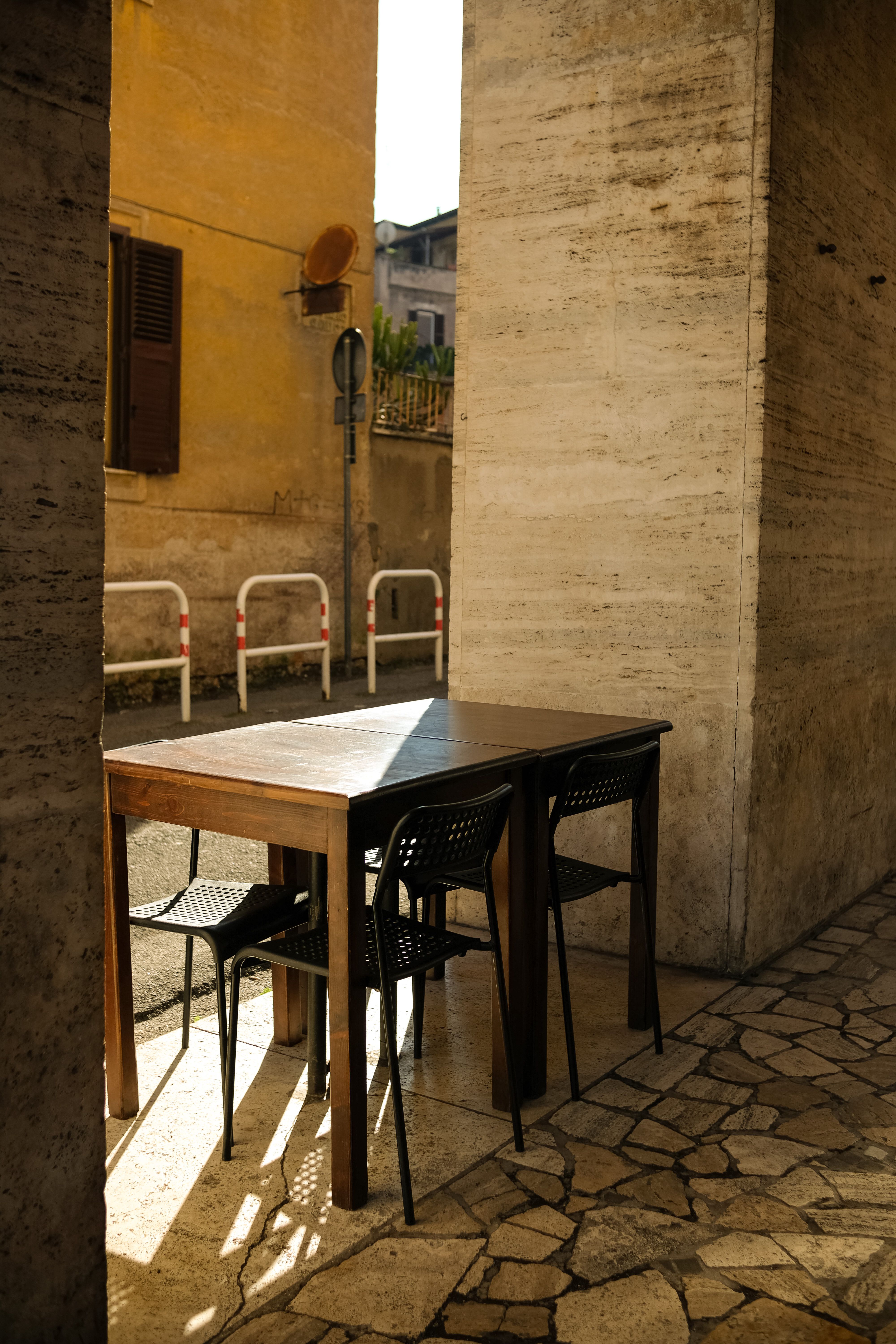 Table with Chairs near Street · Free Stock Photo