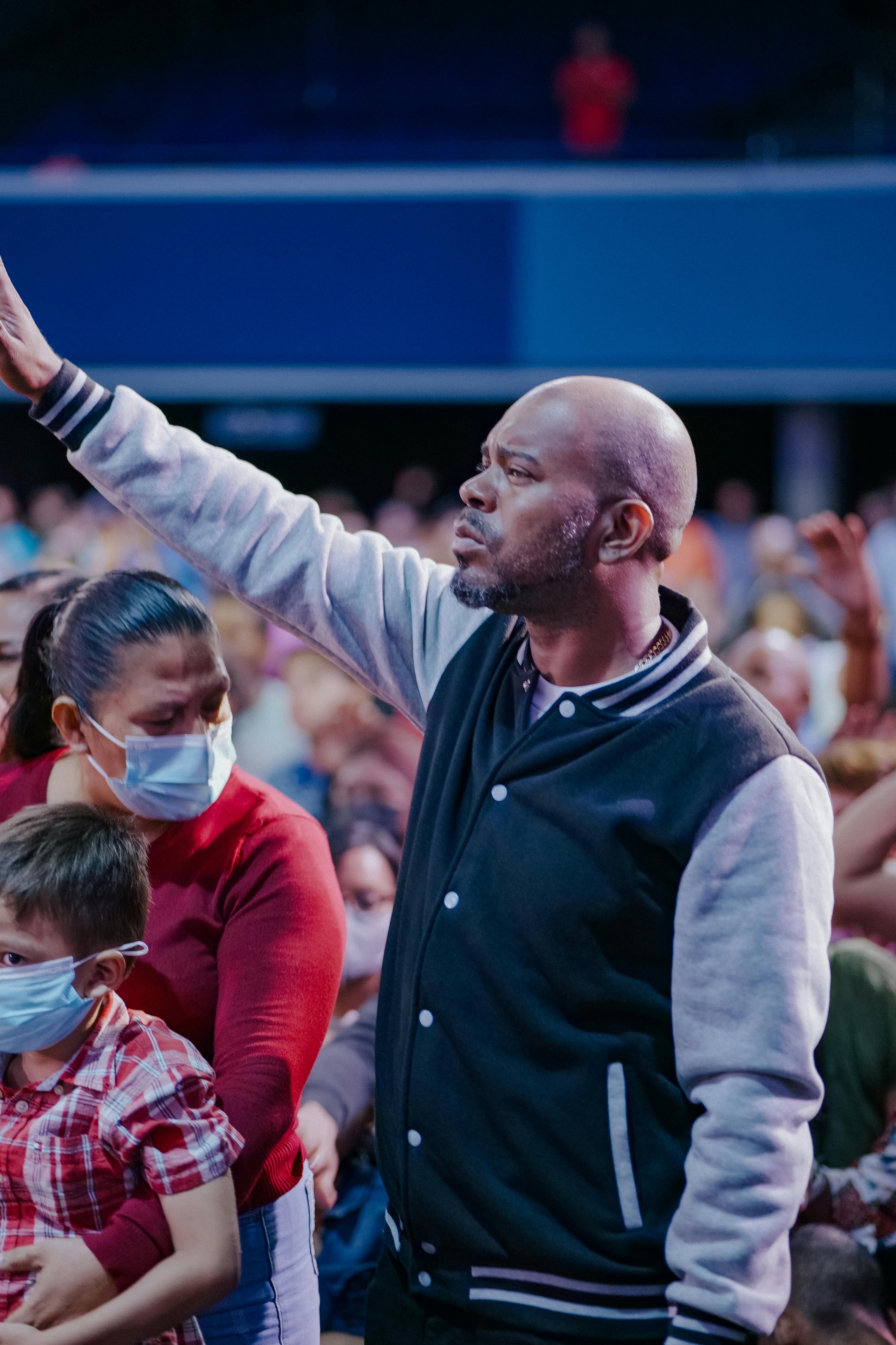 Saluting Man in Crowd · Free Stock Photo