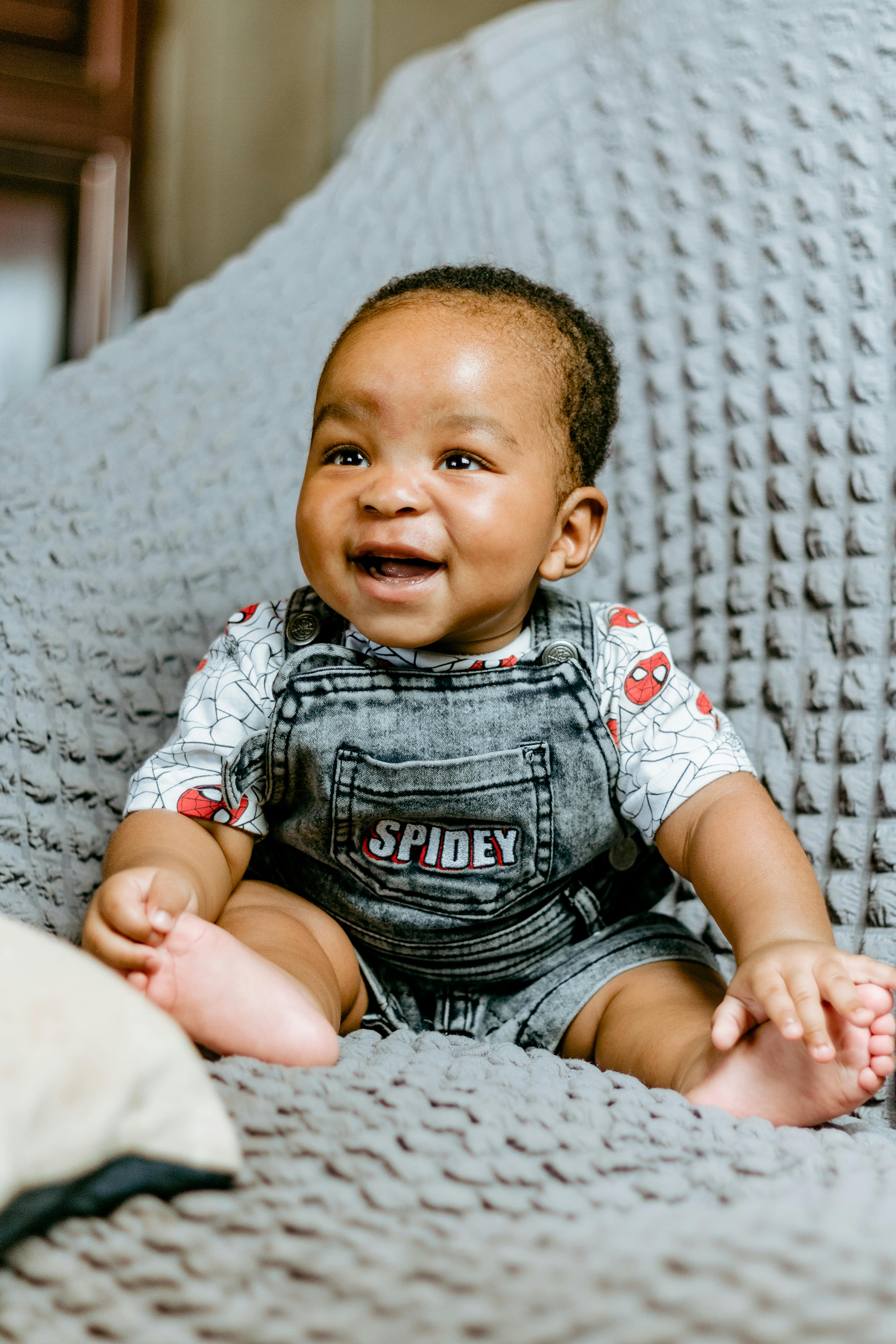 Baby Sitting and Smiling · Free Stock Photo