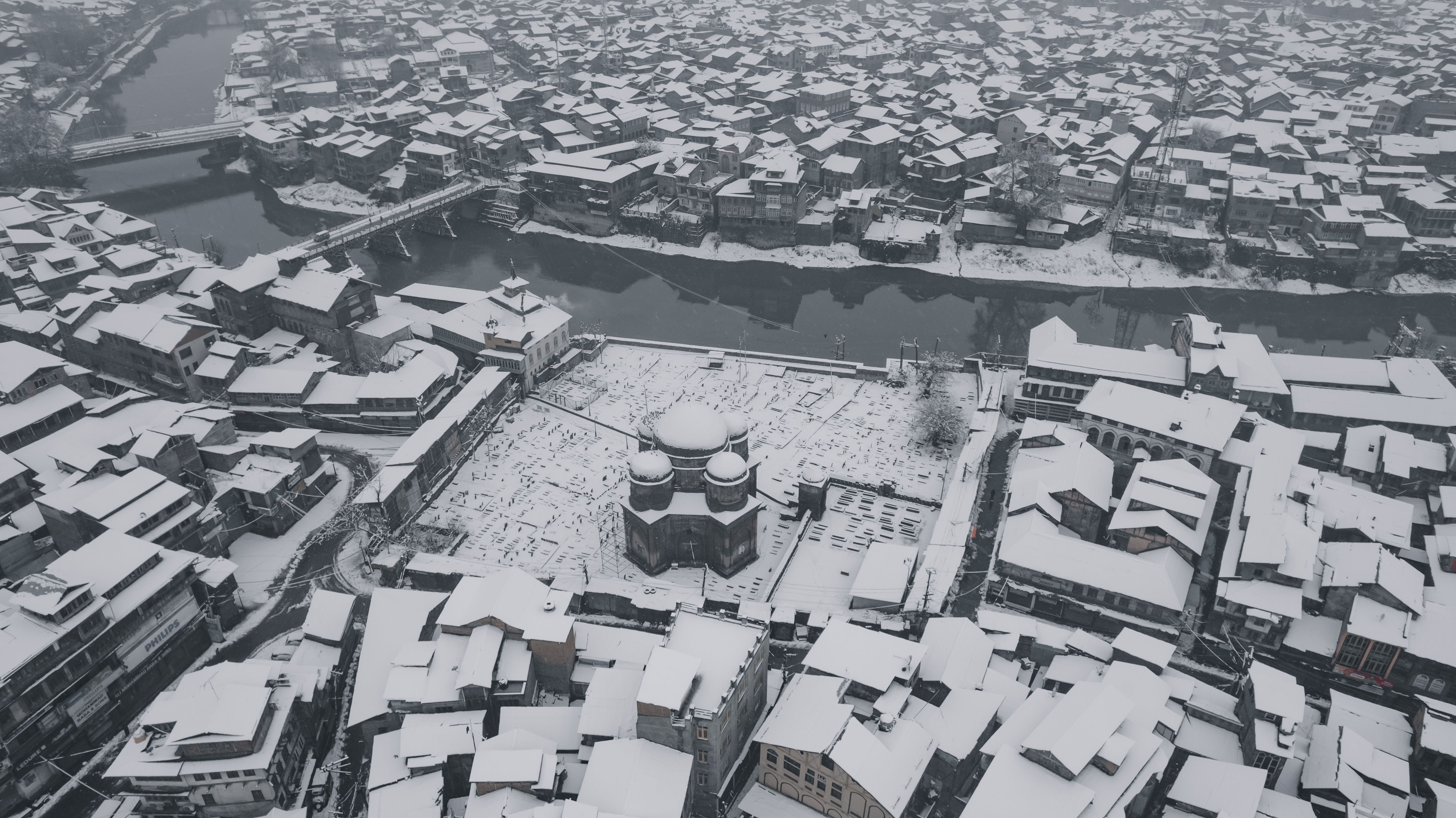 An aerial view of a snowy city with buildings · Free Stock Photo
