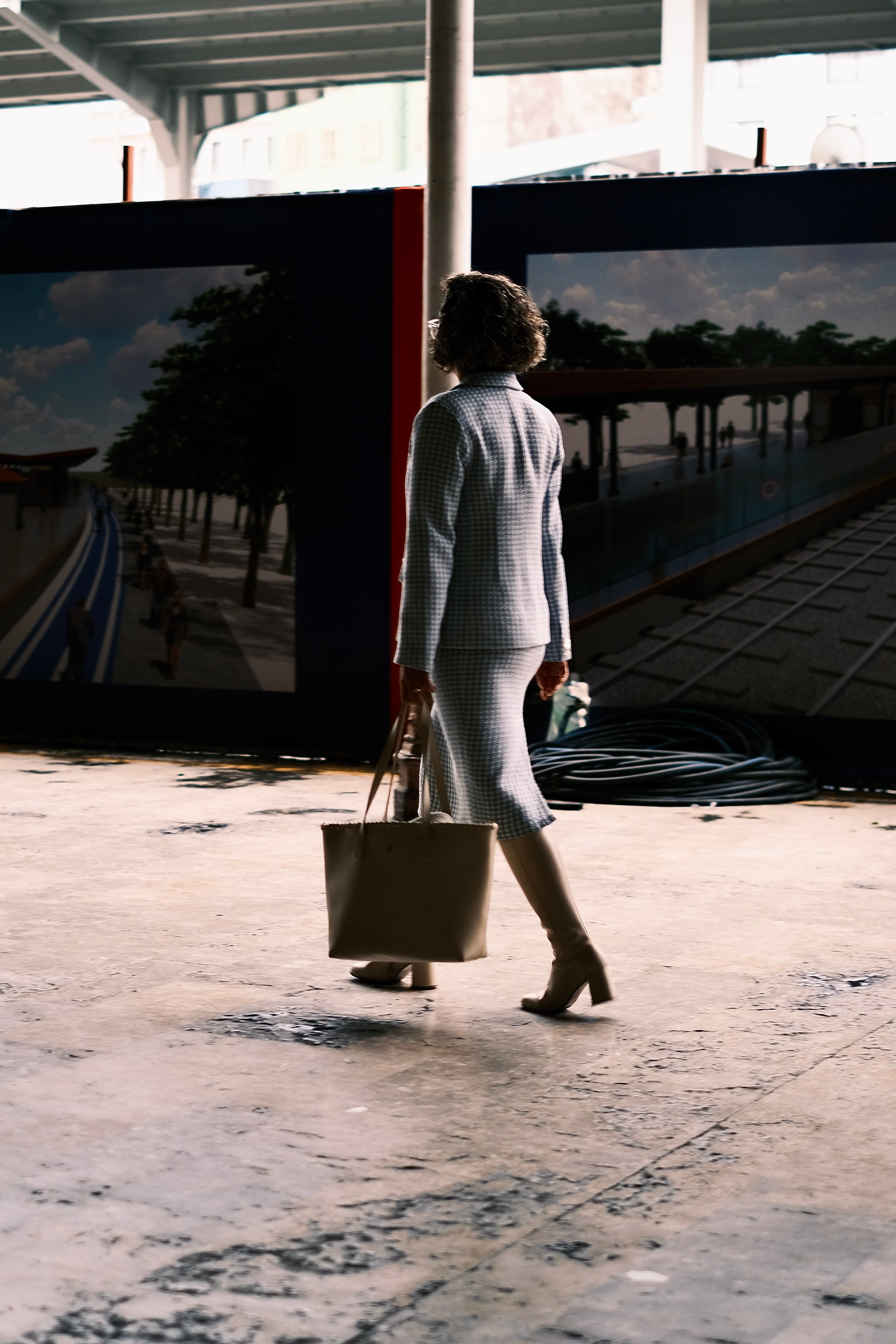 Woman Walking near Paintings · Free Stock Photo