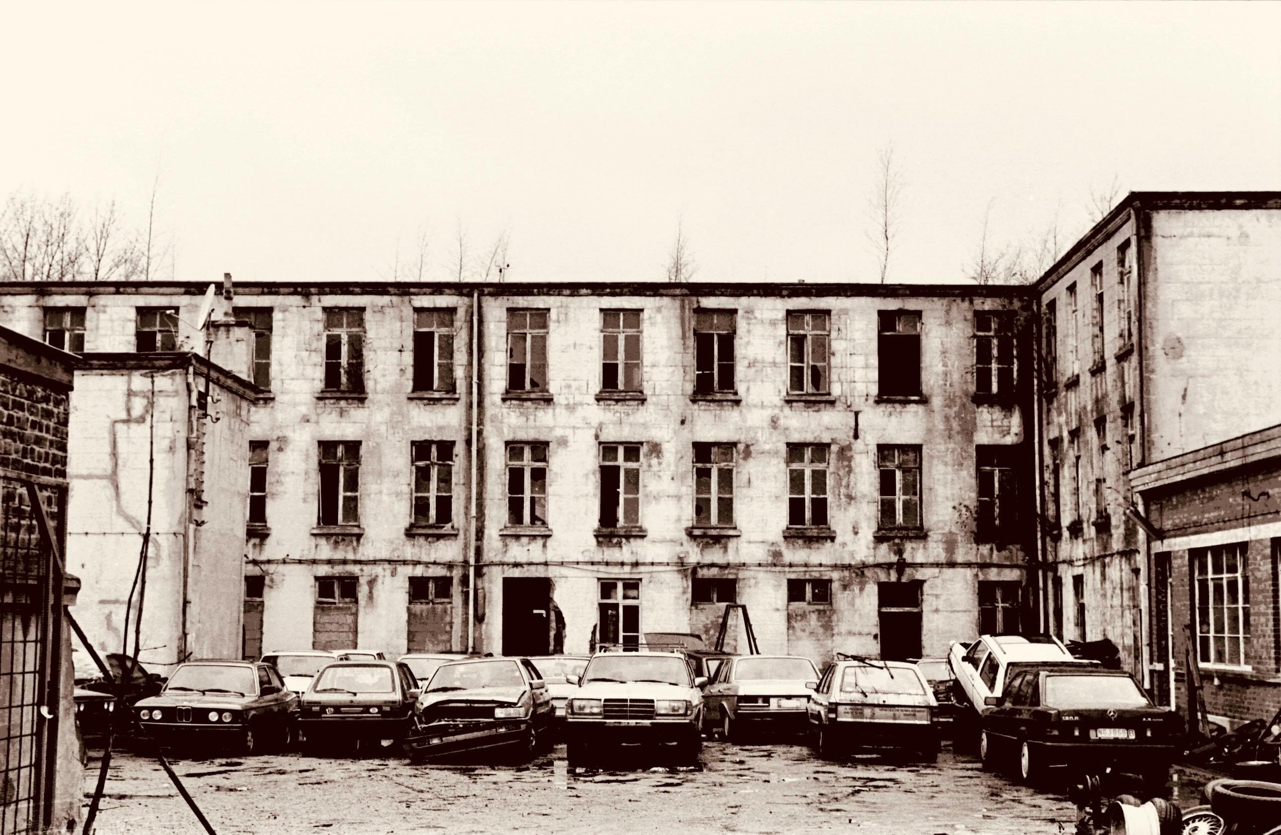 Retro Vehicles Parked under Abandoned Two Story Building · Free Stock Photo