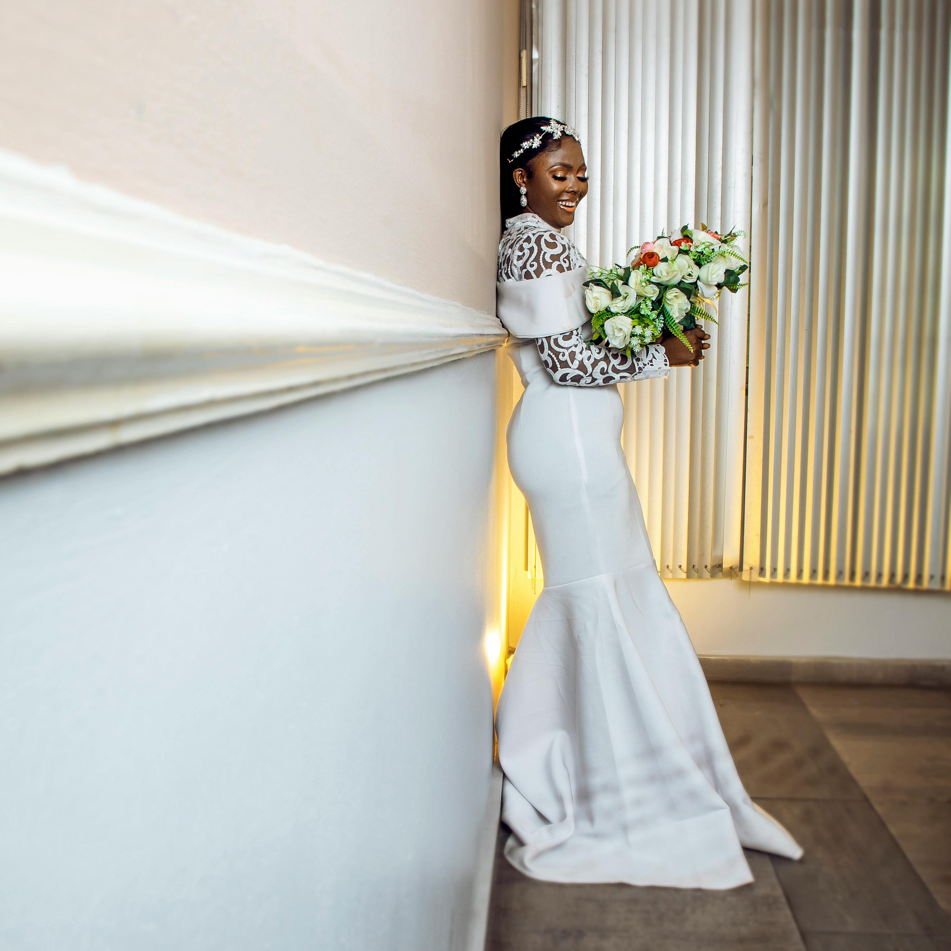 Smiling Bride Leaning against Wall · Free Stock Photo