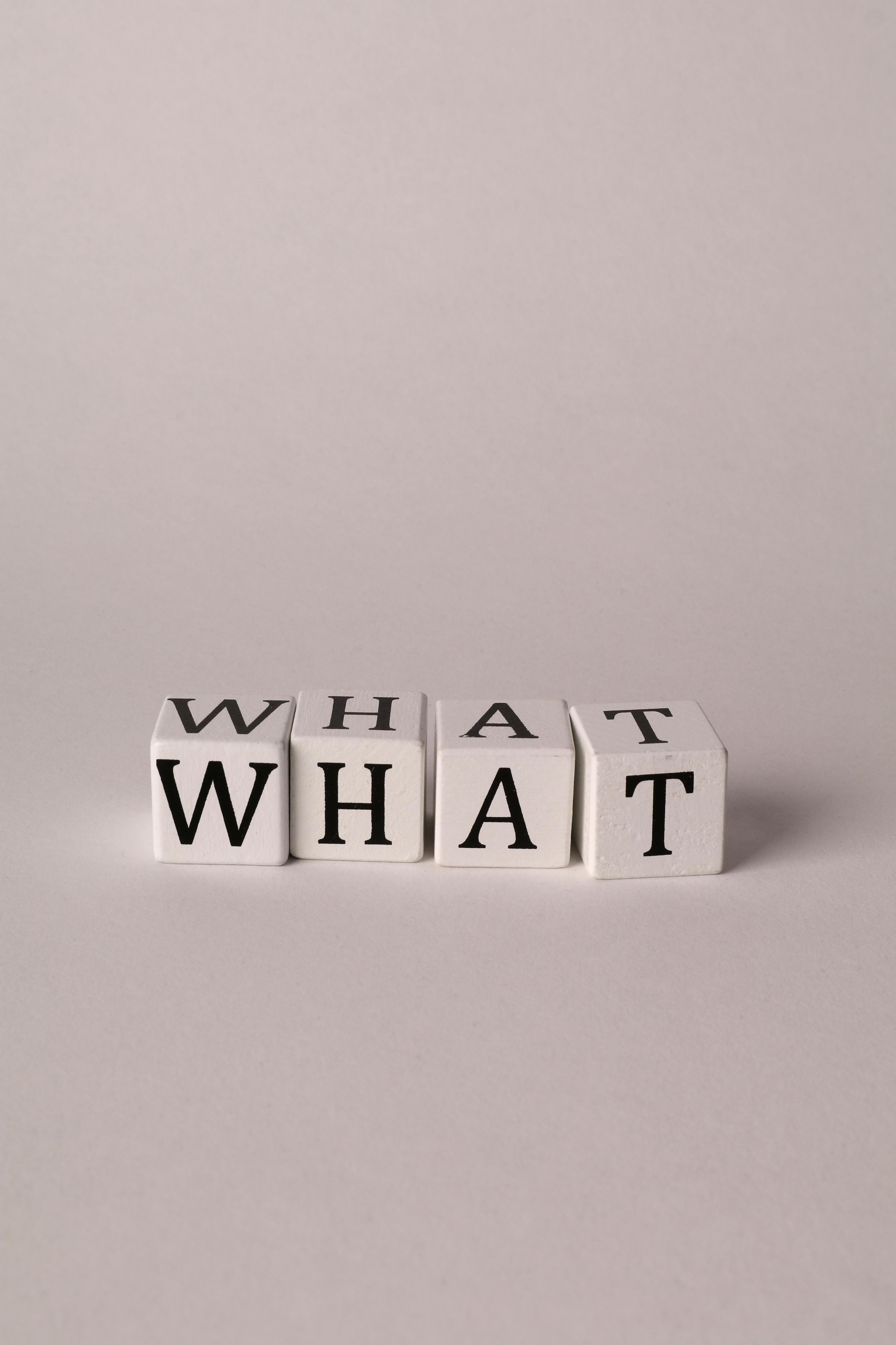 A Close-Up Shot of Letter Dice on an Open Notebook · Free Stock Photo