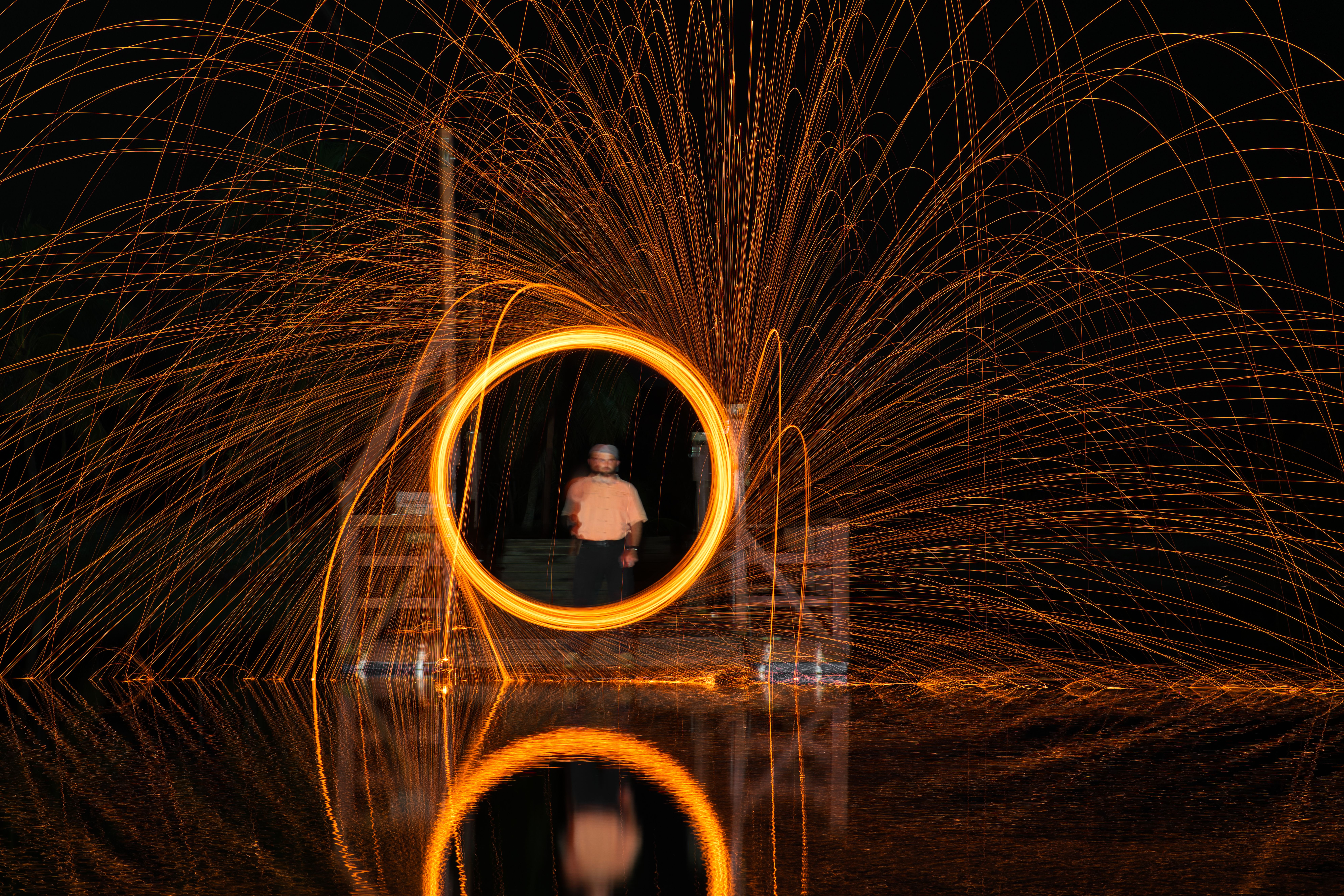 A Man Standing Near Illuminated Lights · Free Stock Photo