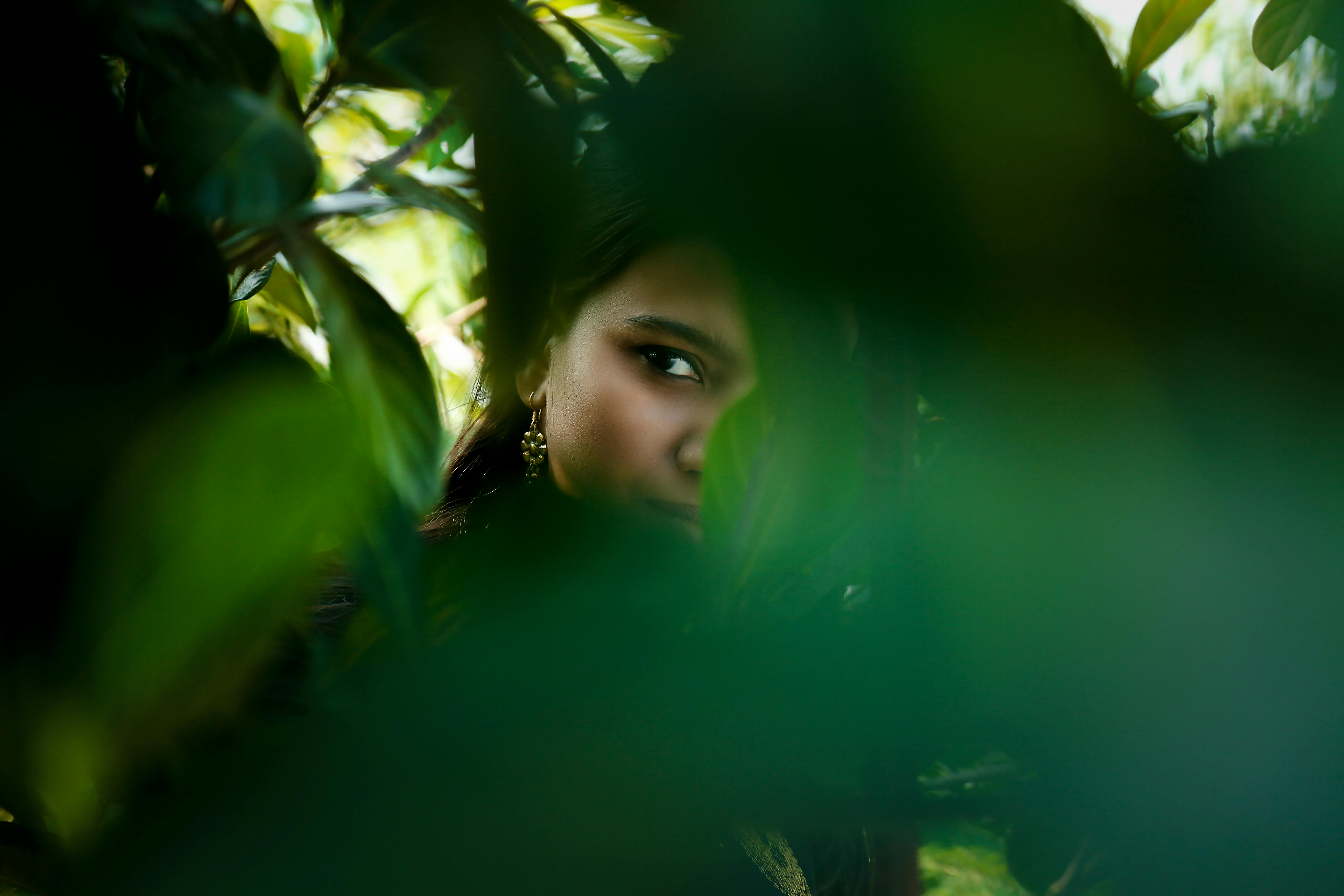 Woman Hiding Beside Tree · Free Stock Photo