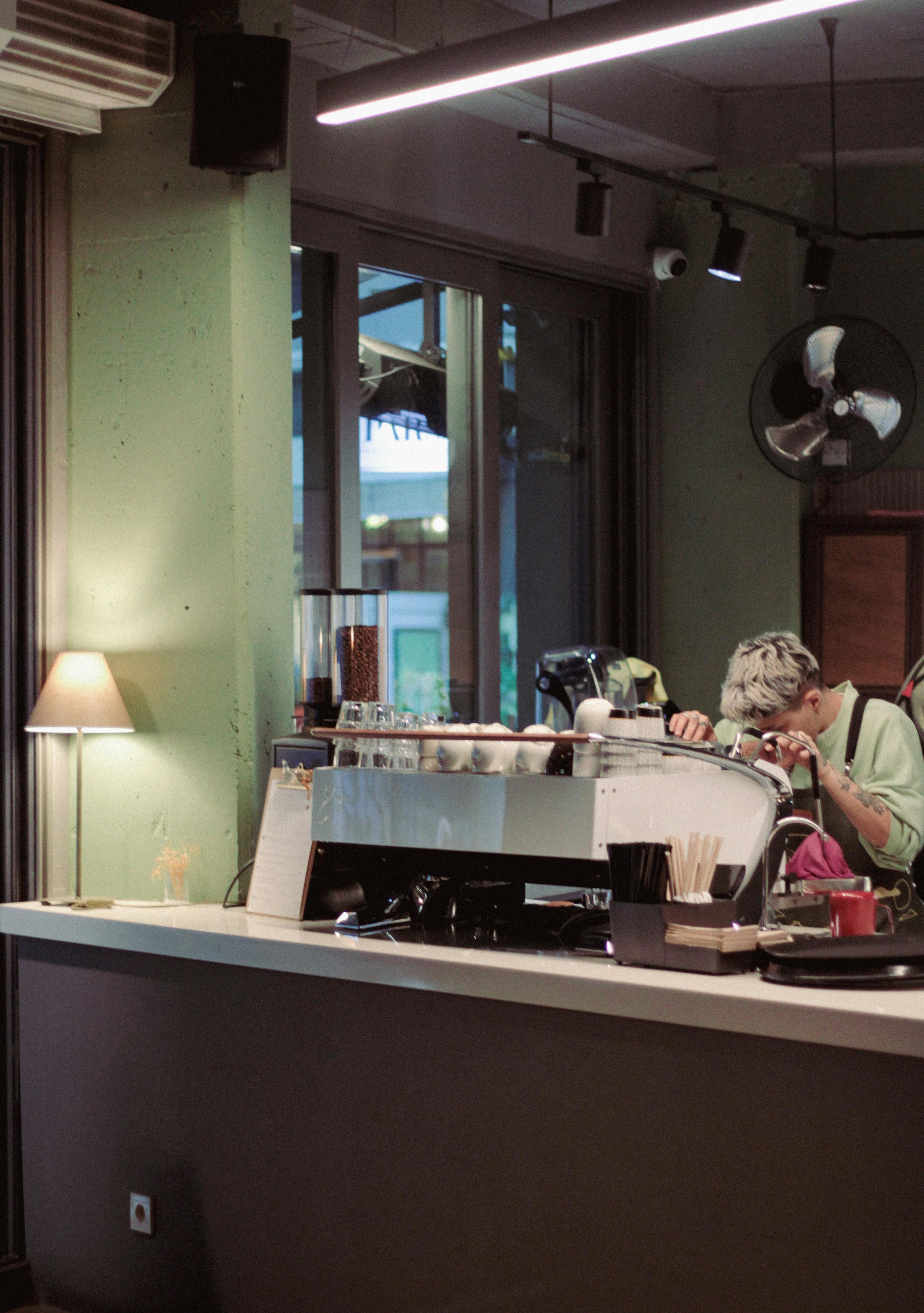 Barista Working Inside a Coffee Shop · Free Stock Photo