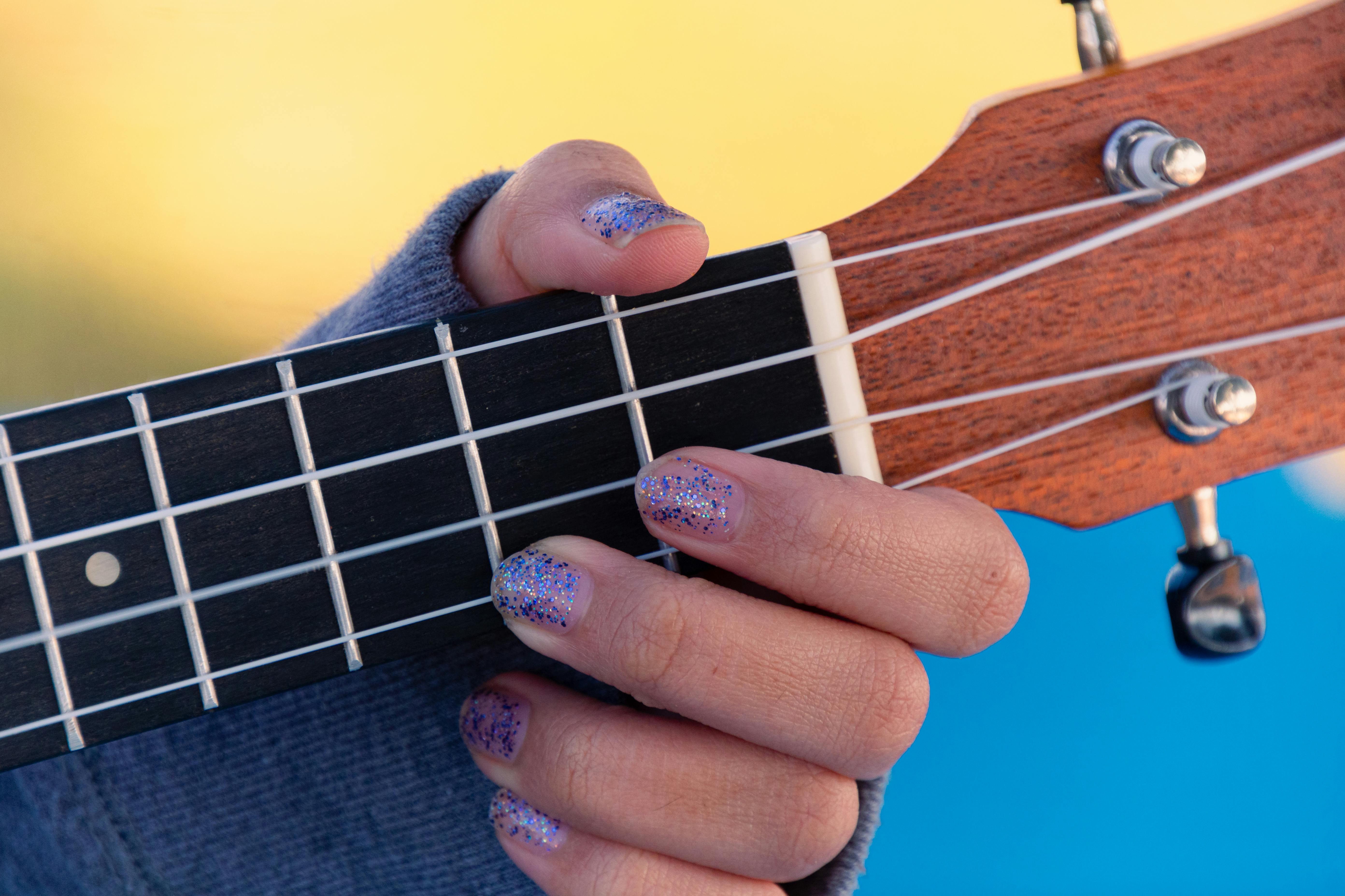 Hand Holding Guitar Neck · Free Stock Photo