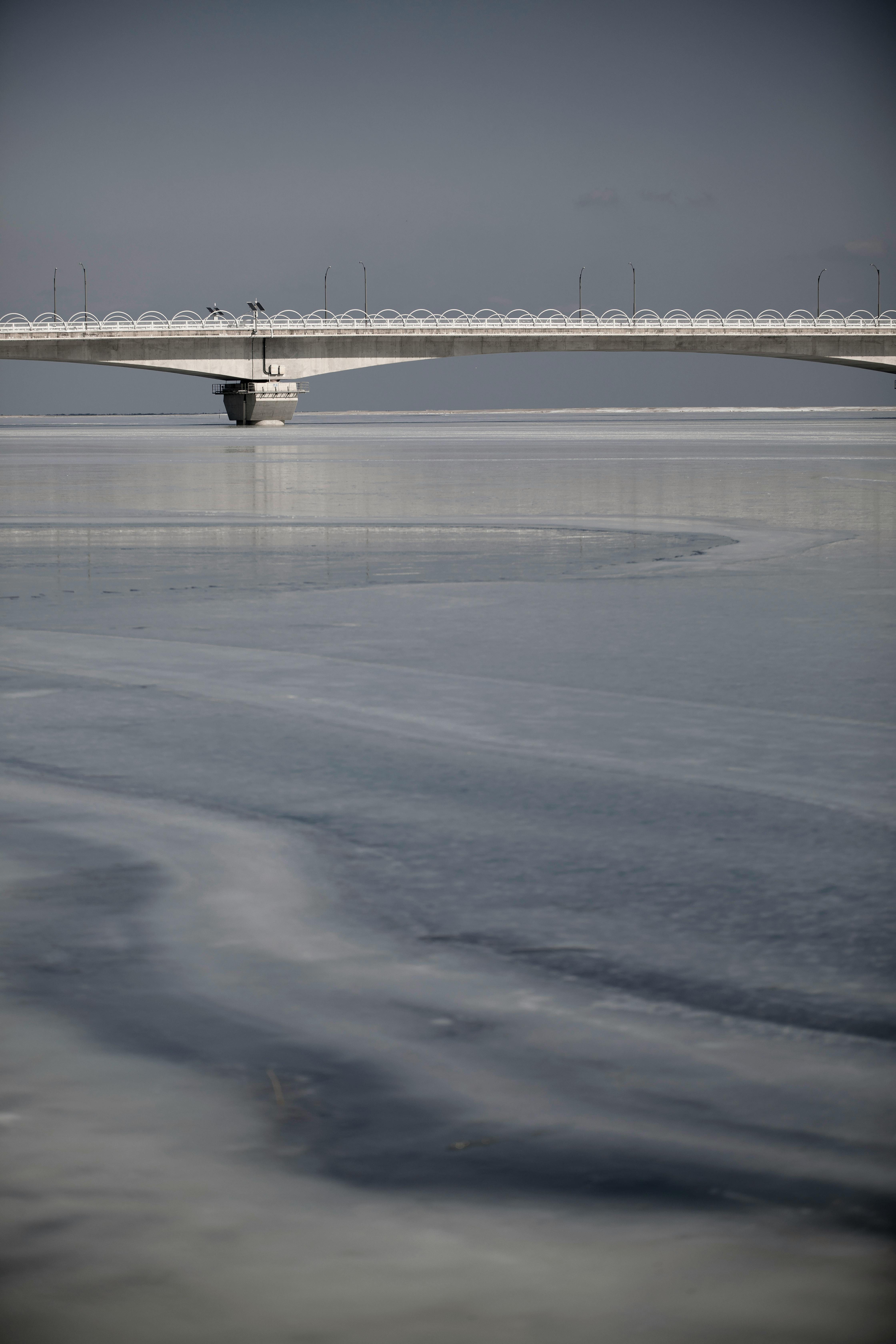 Ice on Water near Bridge · Free Stock Photo