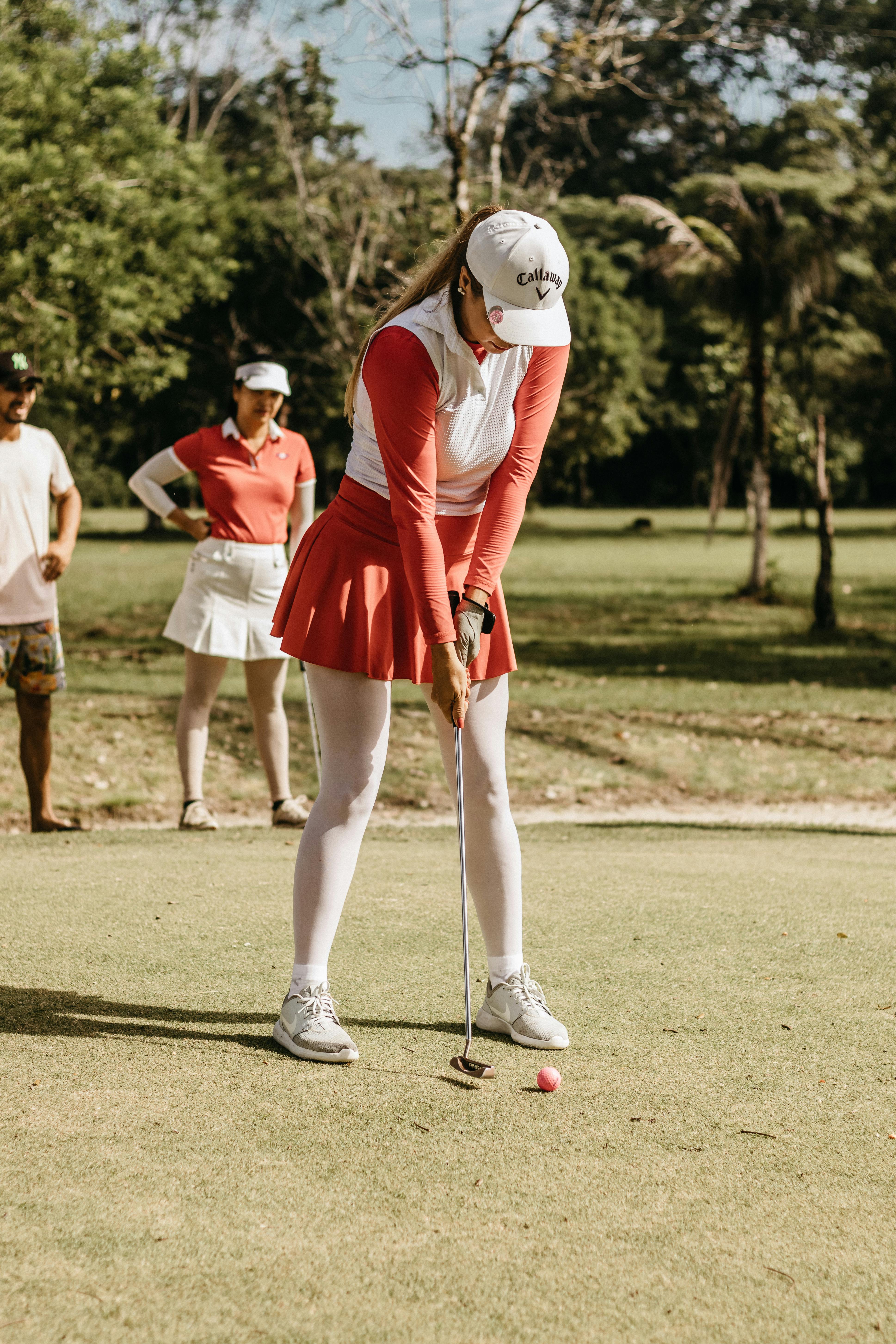 Woman Practicing her Golf Swing · Free Stock Photo