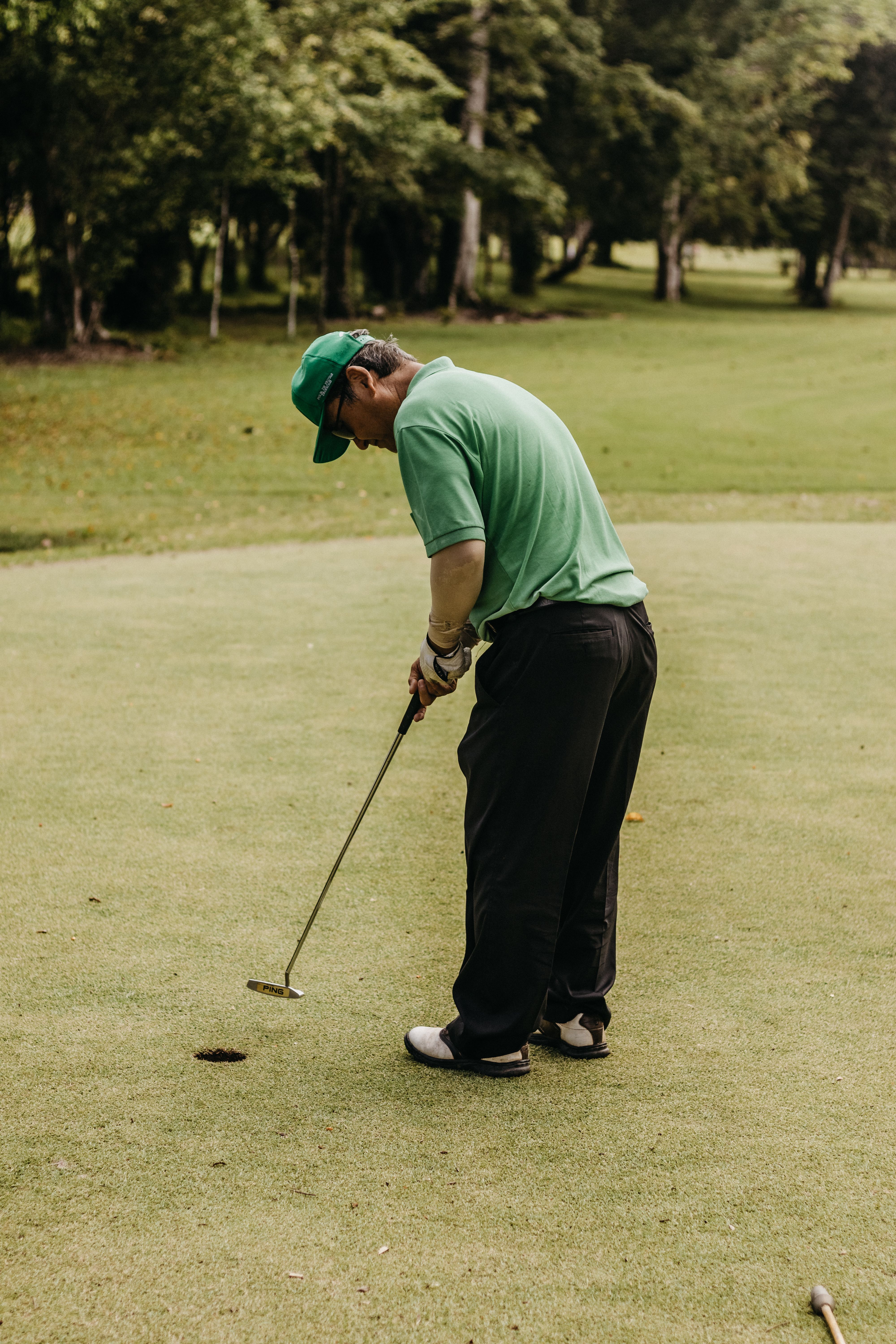 A Man Holding a Golf Club · Free Stock Photo