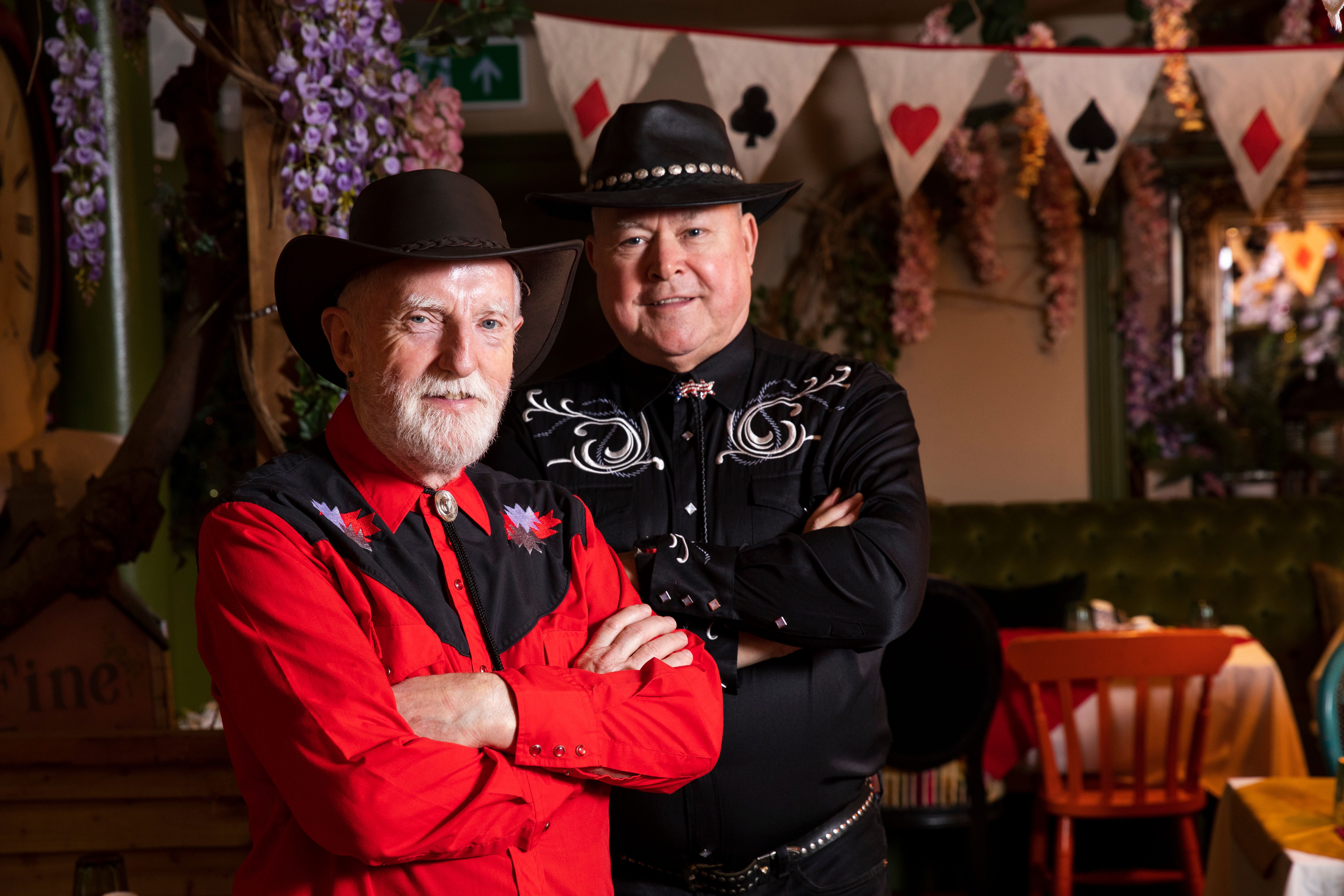 Two Elderly Men in Cowboy Shirts and Hats Standing with Their Arms ...