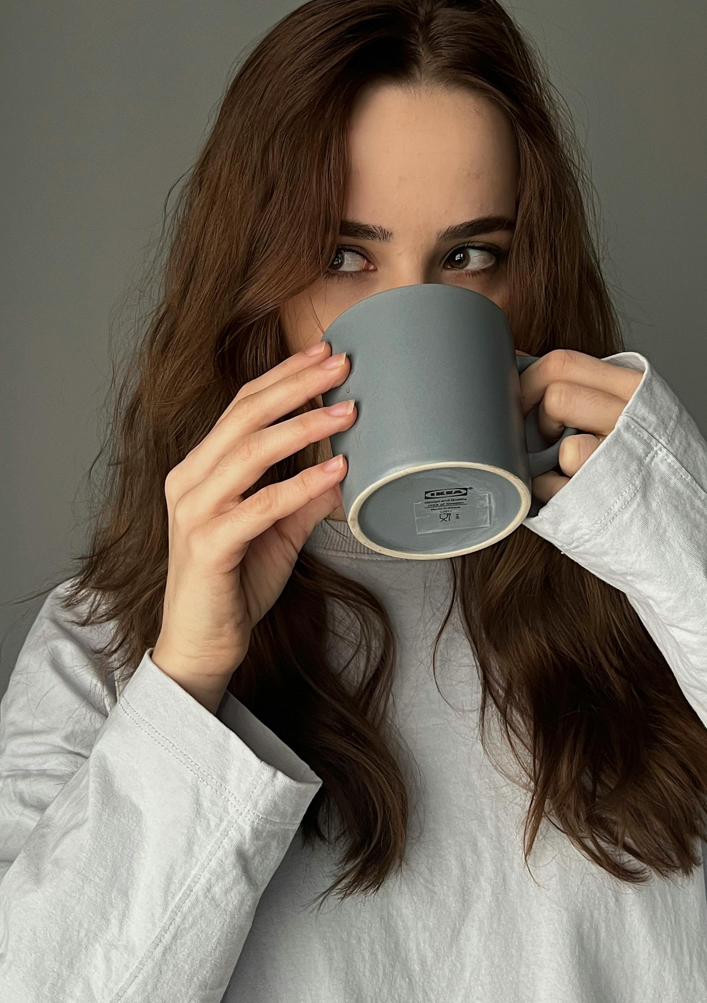 A Woman Drinking From a Mug · Free Stock Photo