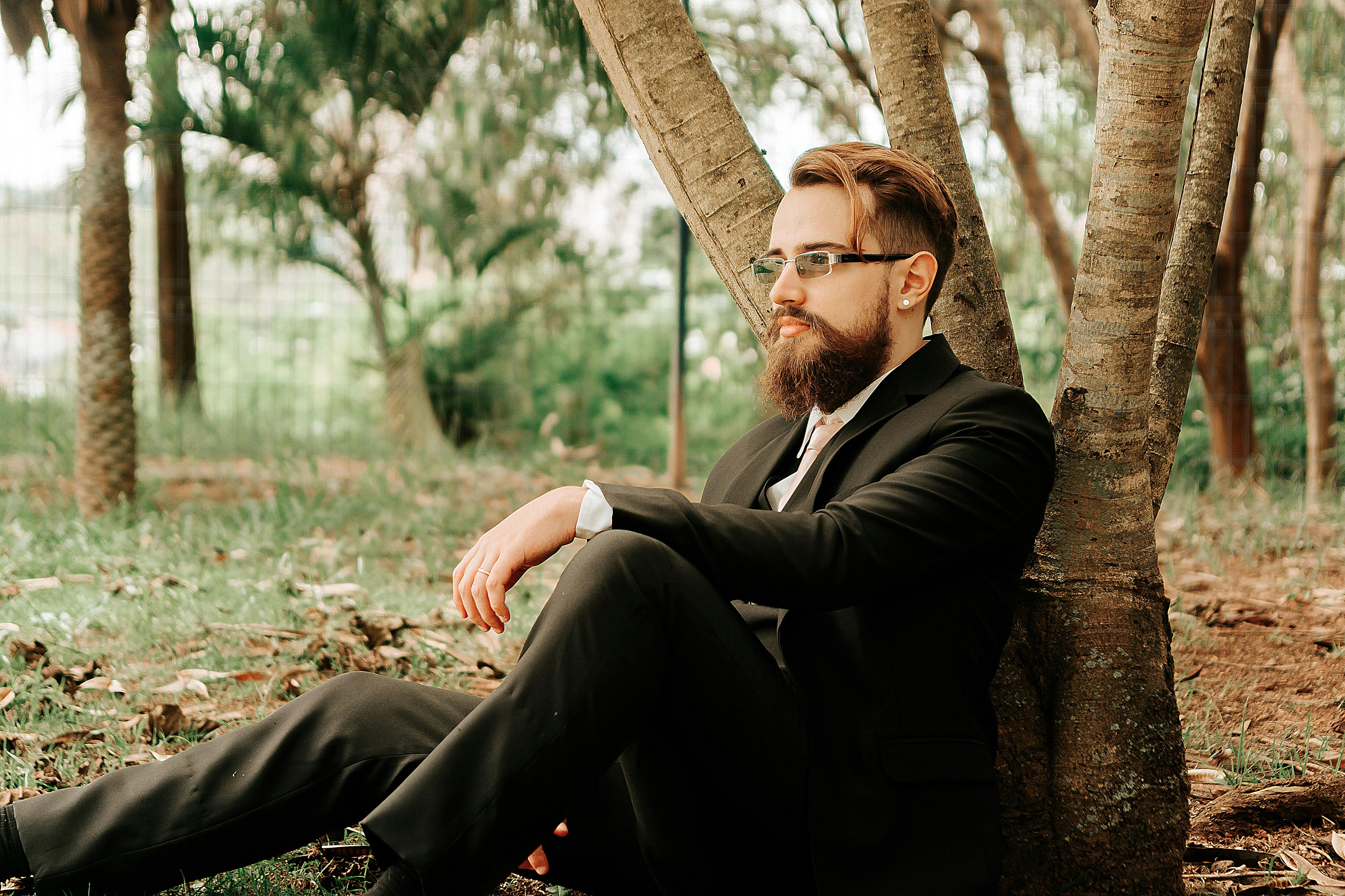 Man Sitting on the Ground Leaning on Tree · Free Stock Photo