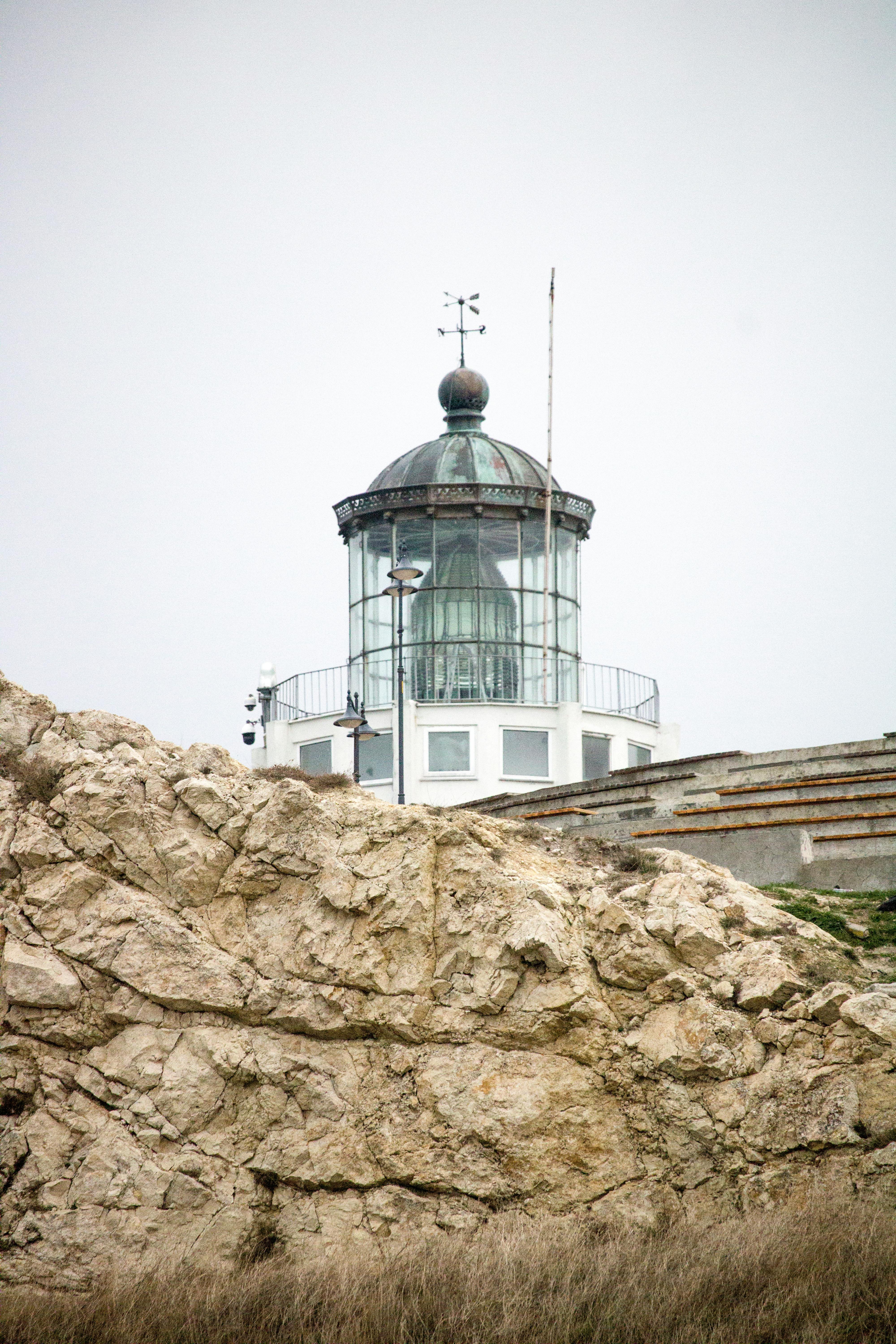 Dramatic Cliffside Lighthouse Overlooking Vast Ocean · Free Stock Photo