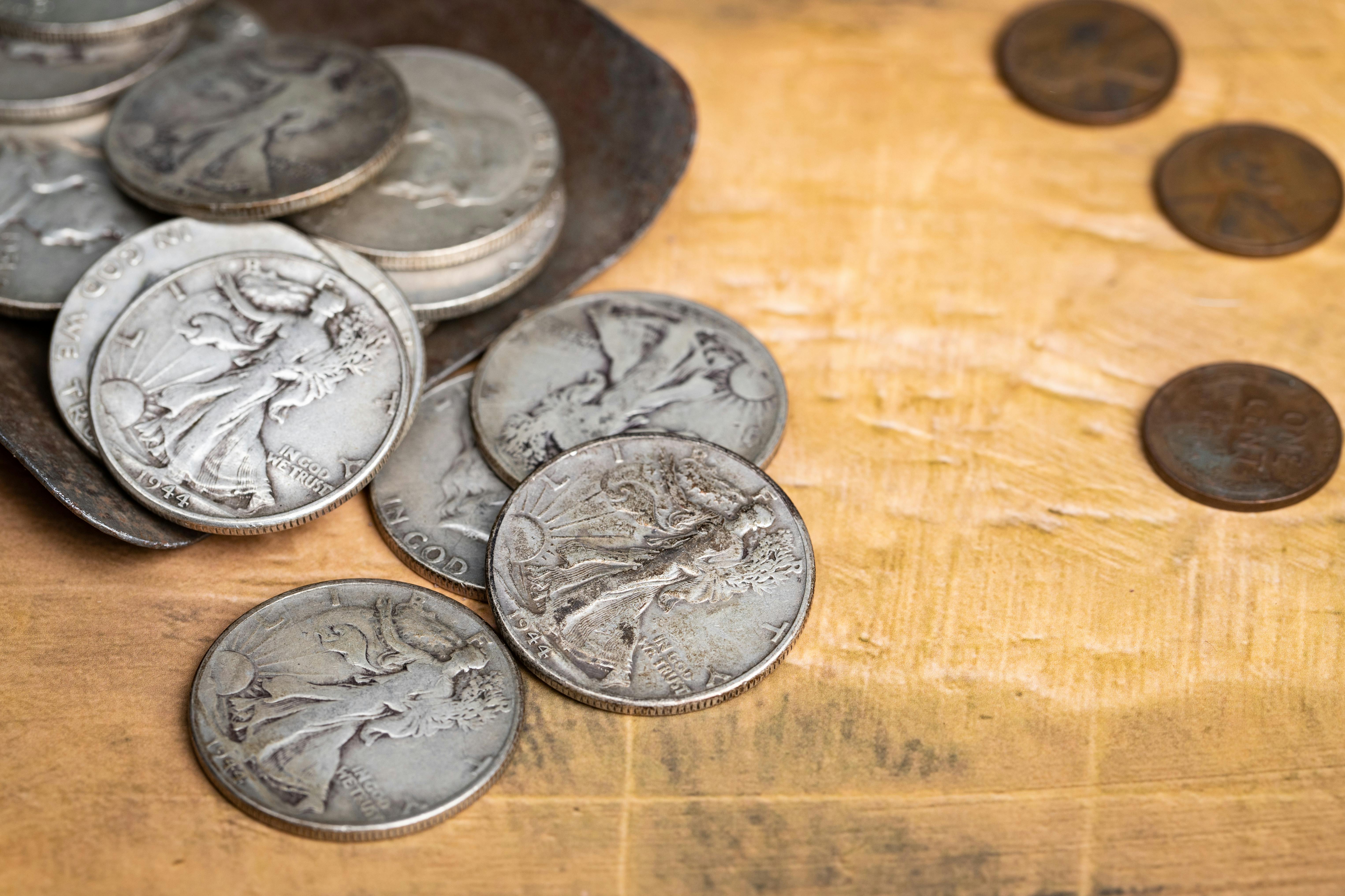 Assorted Silver-and-gold-colored Coins on Gray Surface · Free Stock Photo