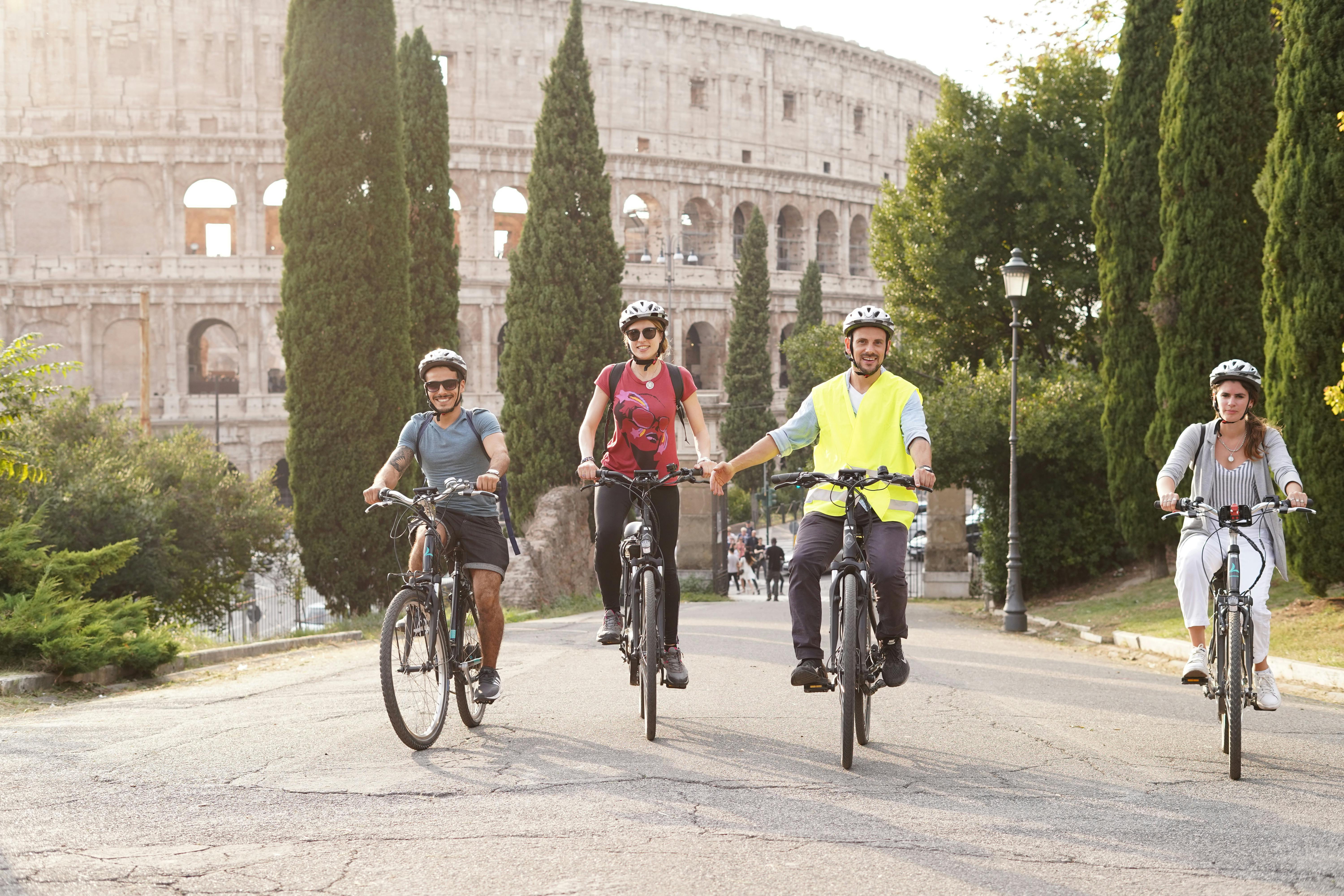 A Group of People Riding on Bicycles in front of the Colosseum in Rome ...