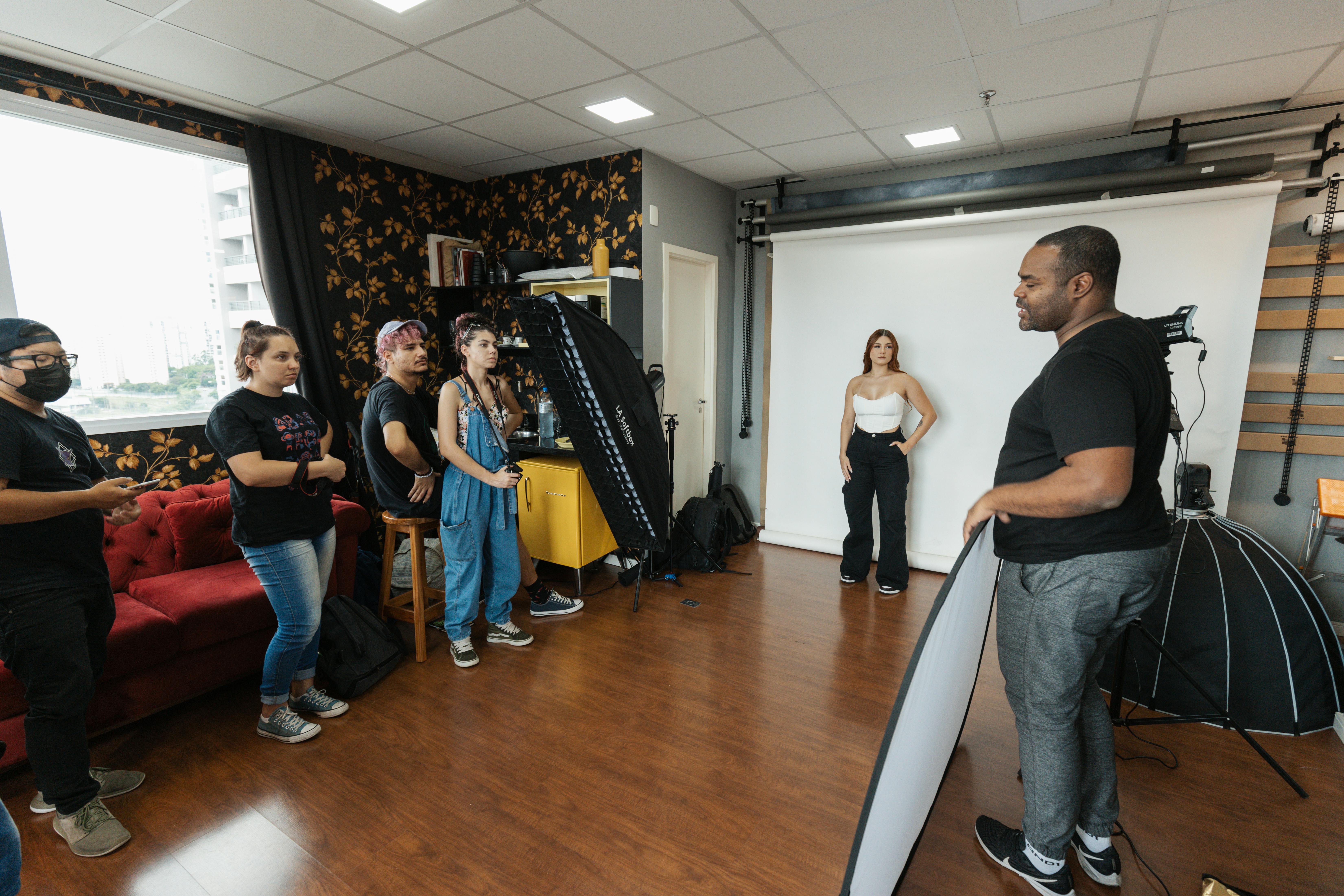 Photo of a Group of People Getting Ready for a Photo Shoot in an ...
